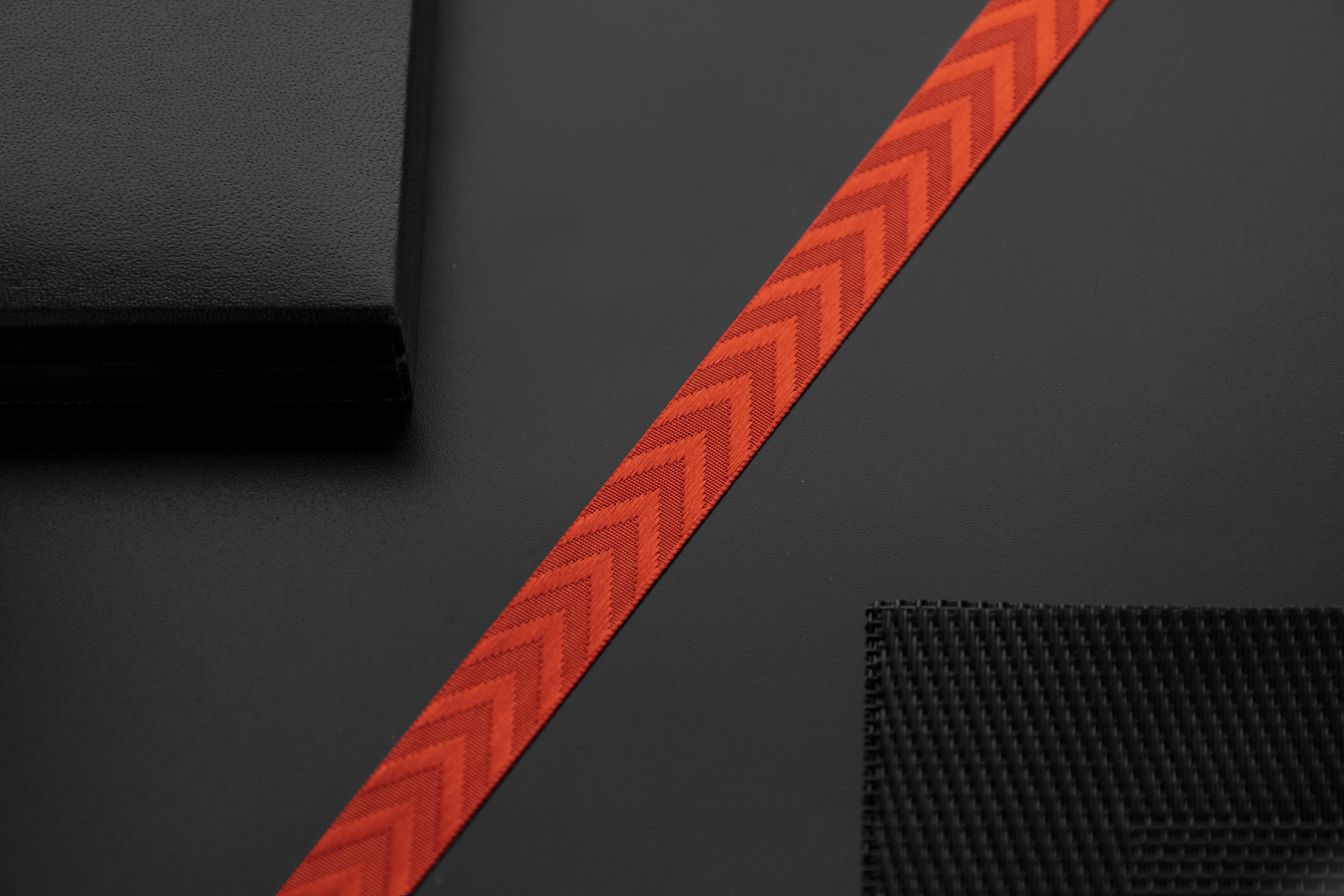 Red ribbon with arrows on black background