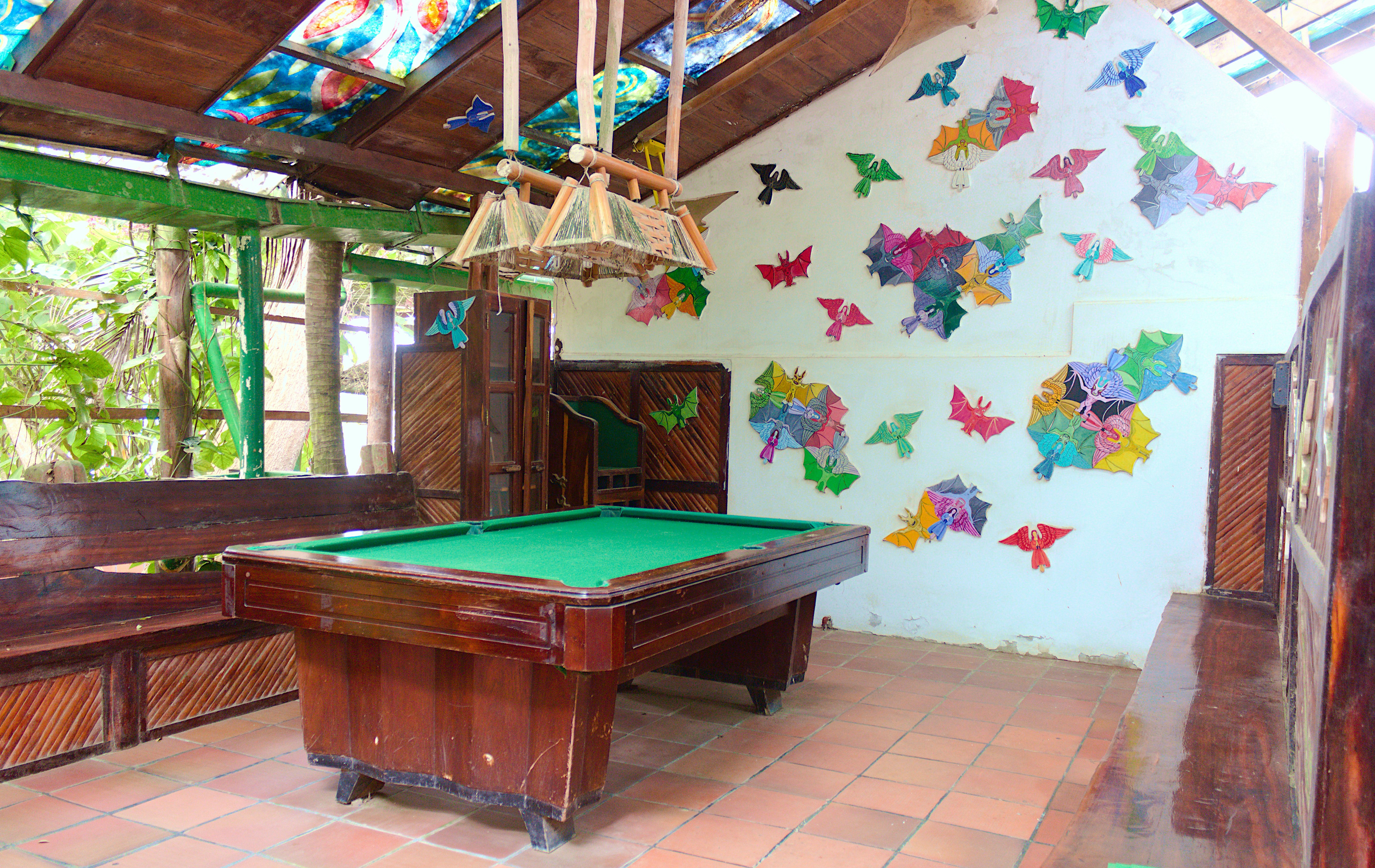 Colorful origami butterflies adorn a cozy billiards nook