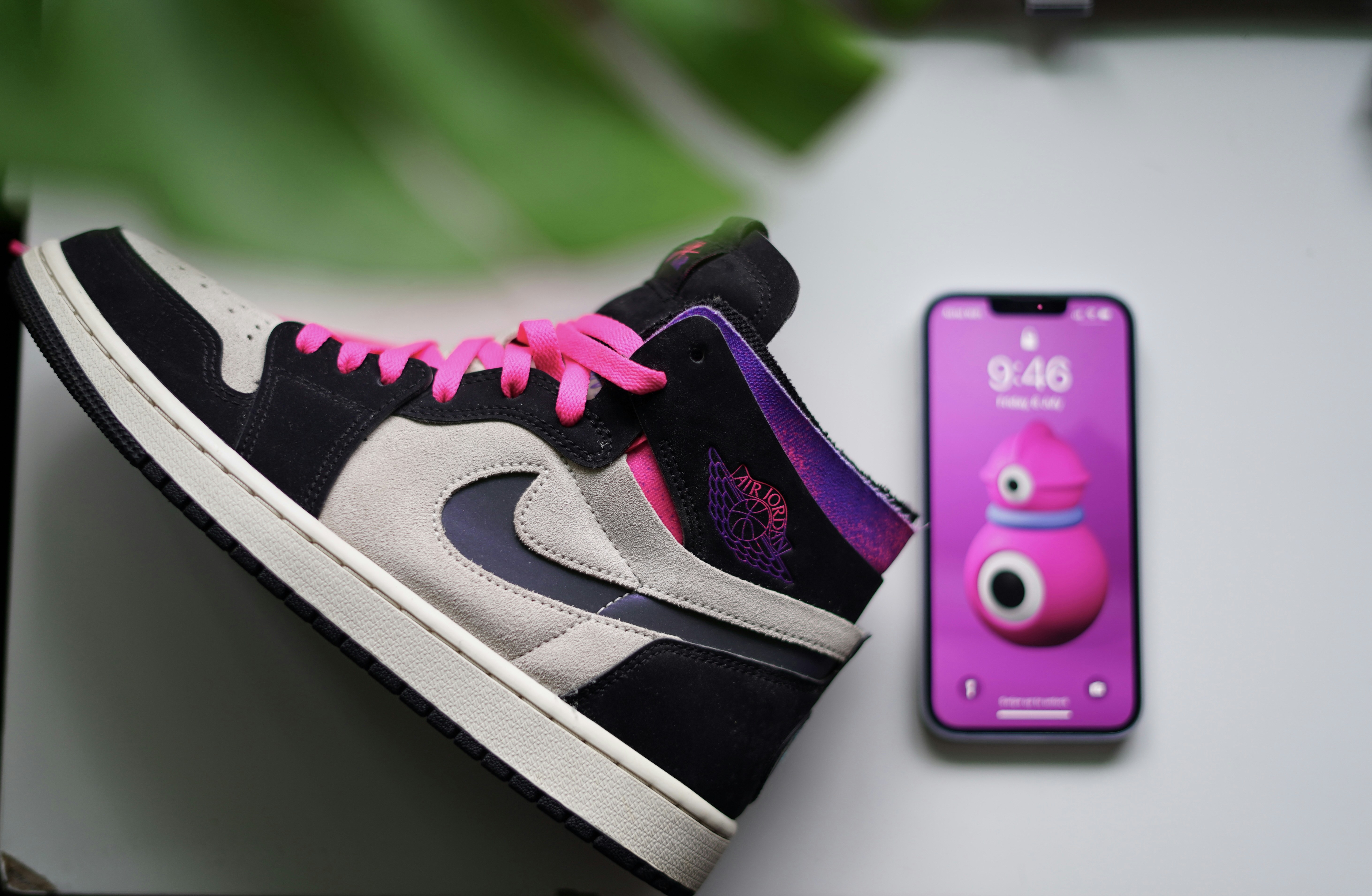 Neon-laced Sneaker Pairing with a Sleek Smartphone