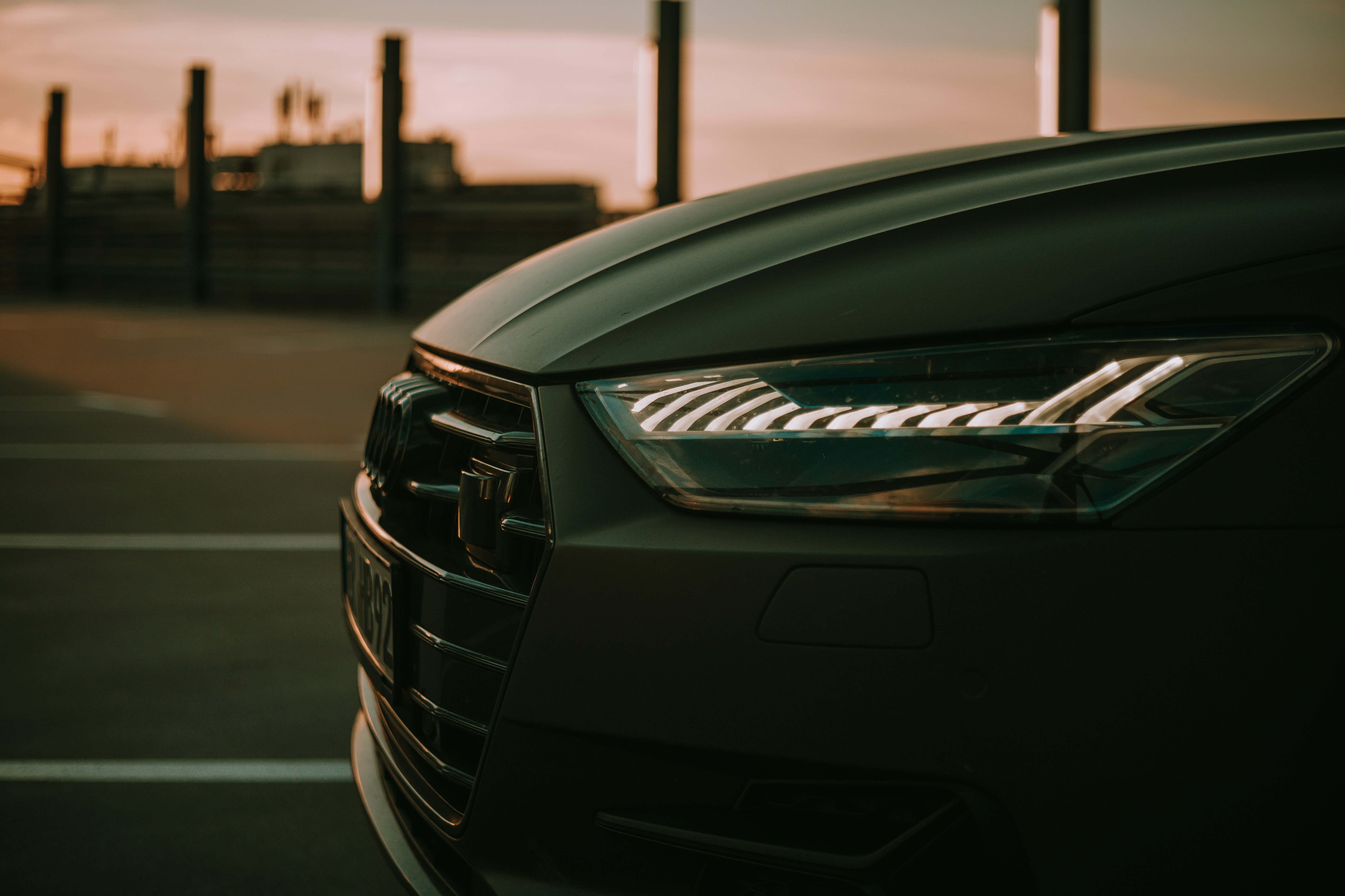 Twilight Glisten: A Sedan's LED Ribbon in the Quiet Parking Lot