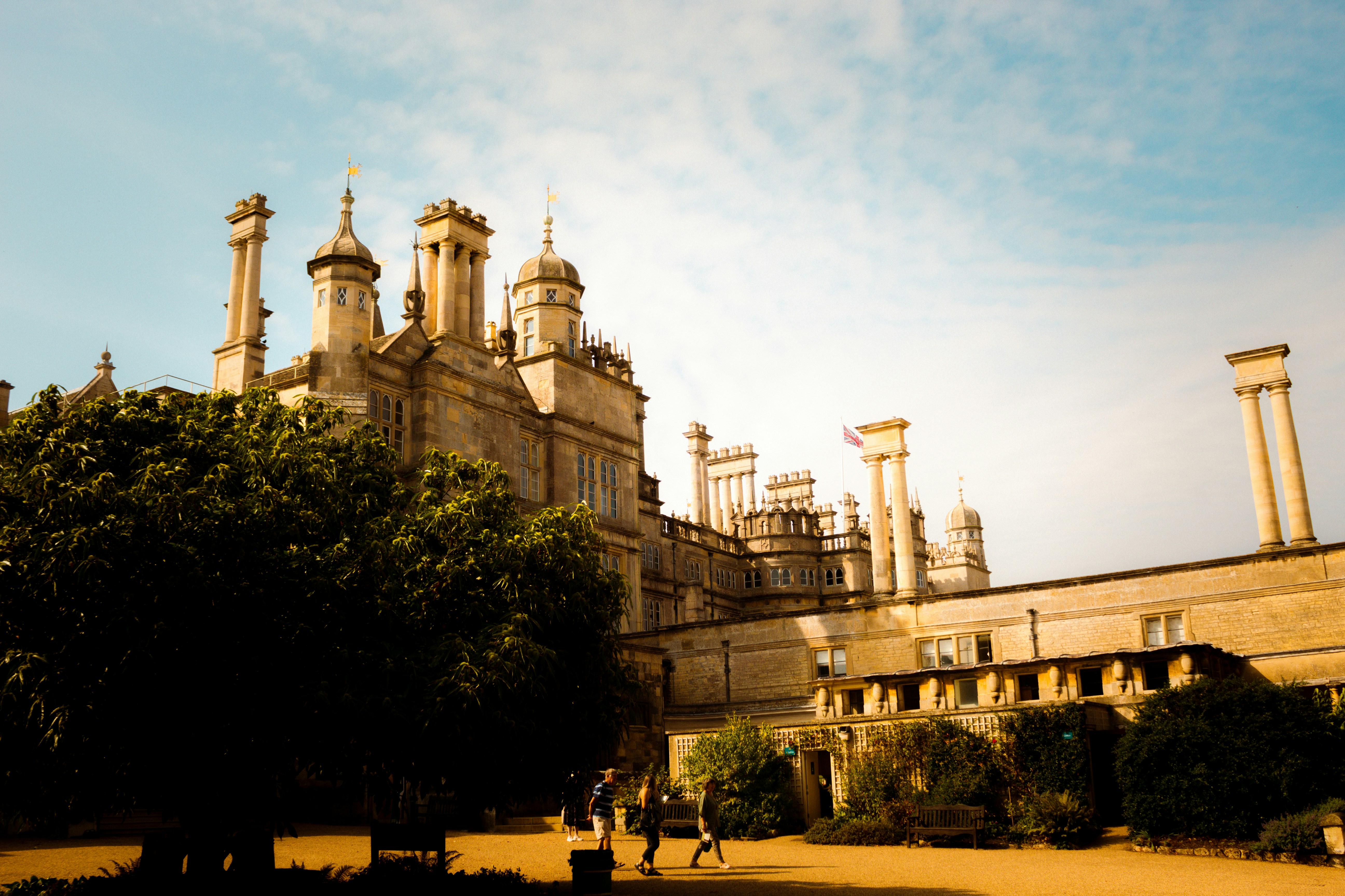 Historic mansion with ornate towers and chimneys under a clear sky.