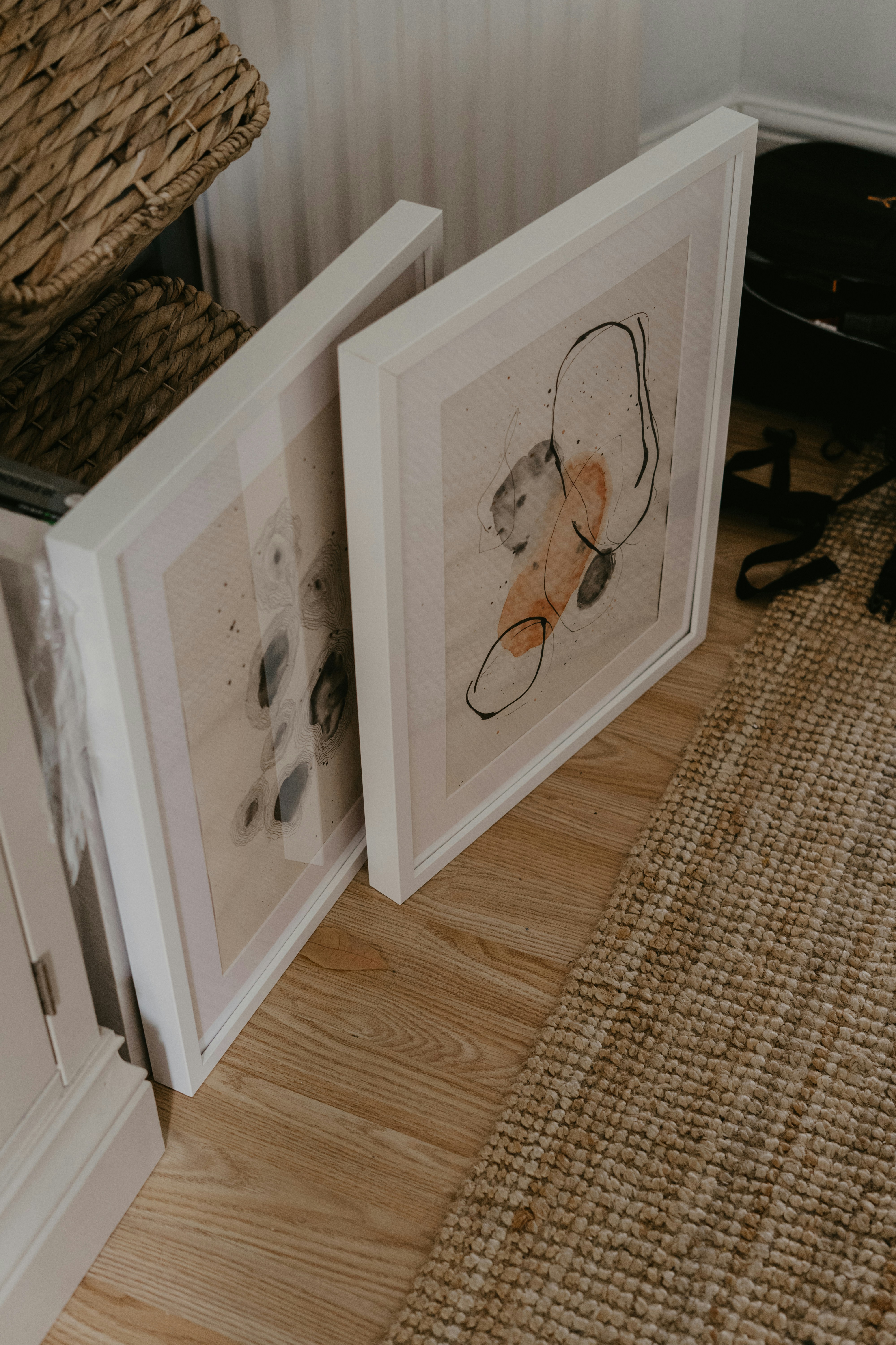 Framed Abstracts Stack Against the Doorway