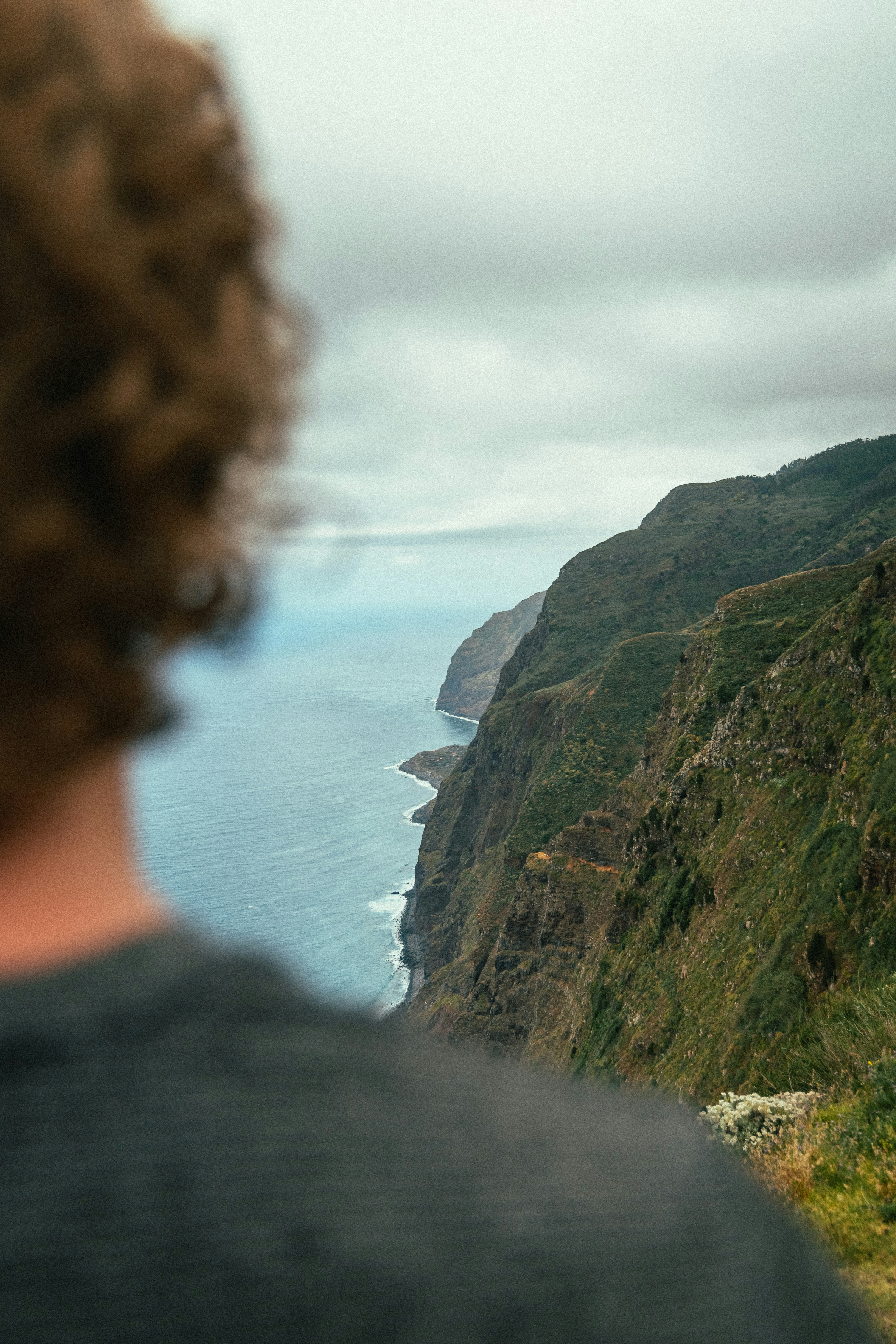 A person looks on at the steep cliffs on Madeira 