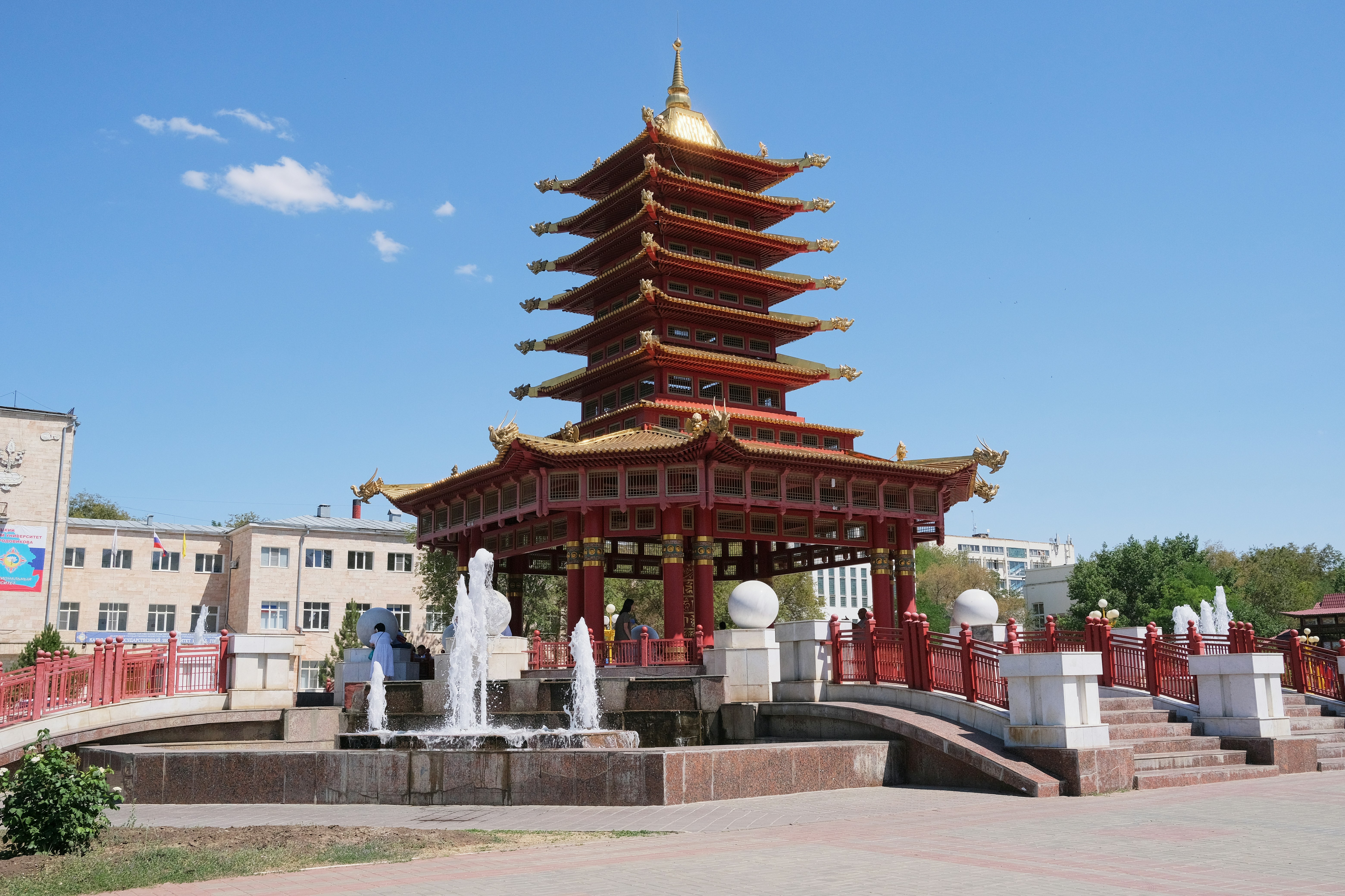 A red asian building with a fountain in front of it photo – Free Elista ...