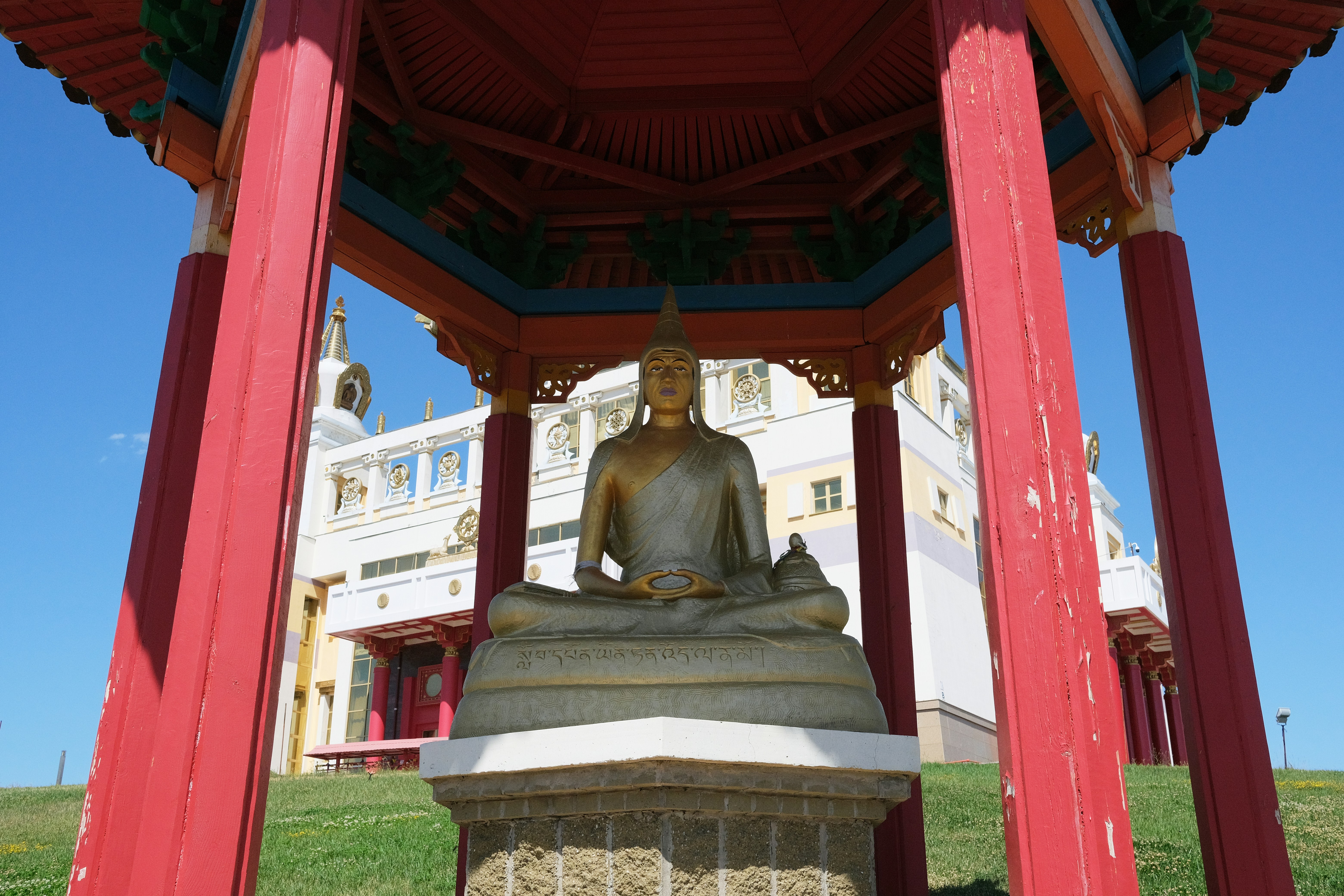 A statue in a red and white structure photo – Free Elista Image on Unsplash
