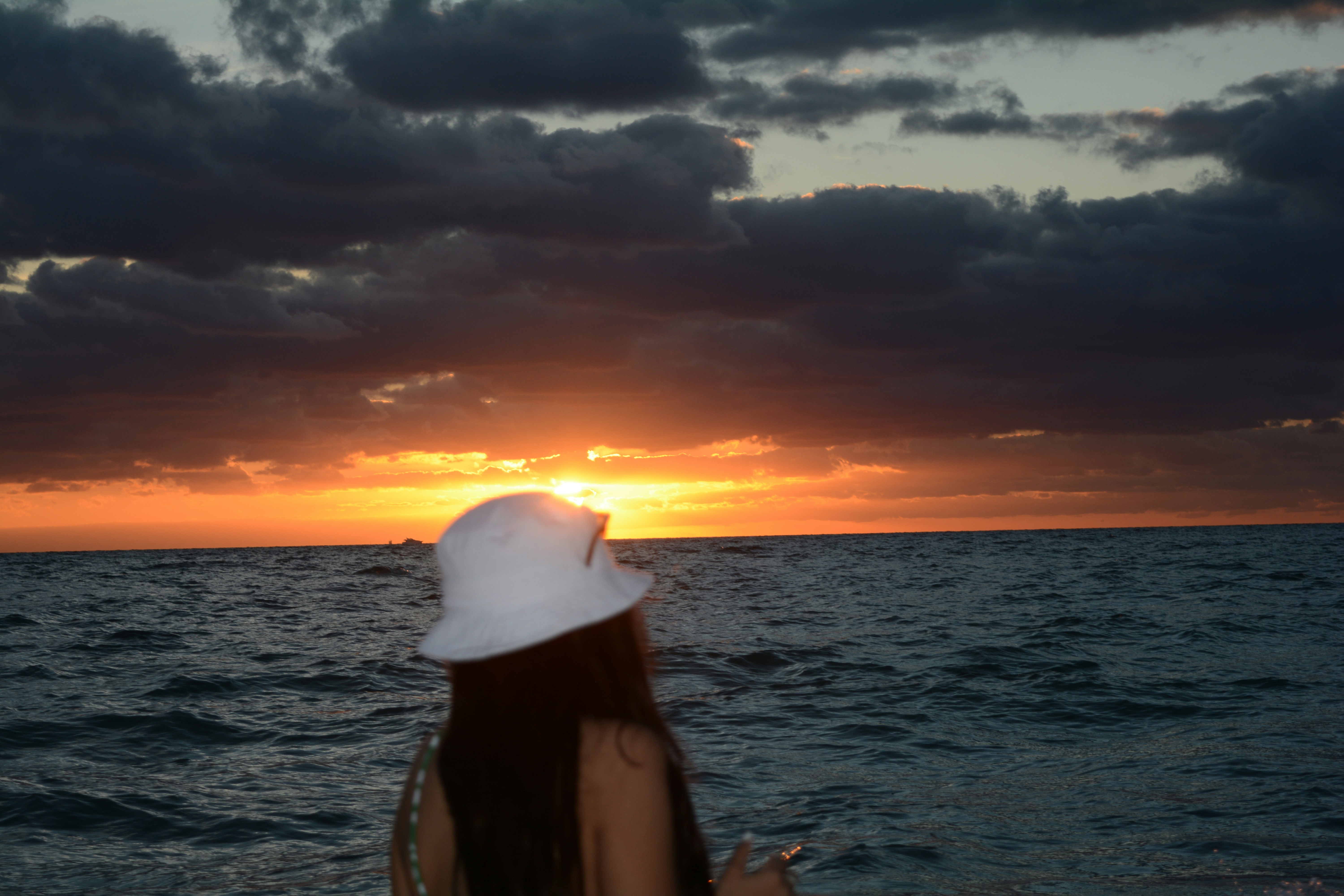 a person standing in front of a sunset