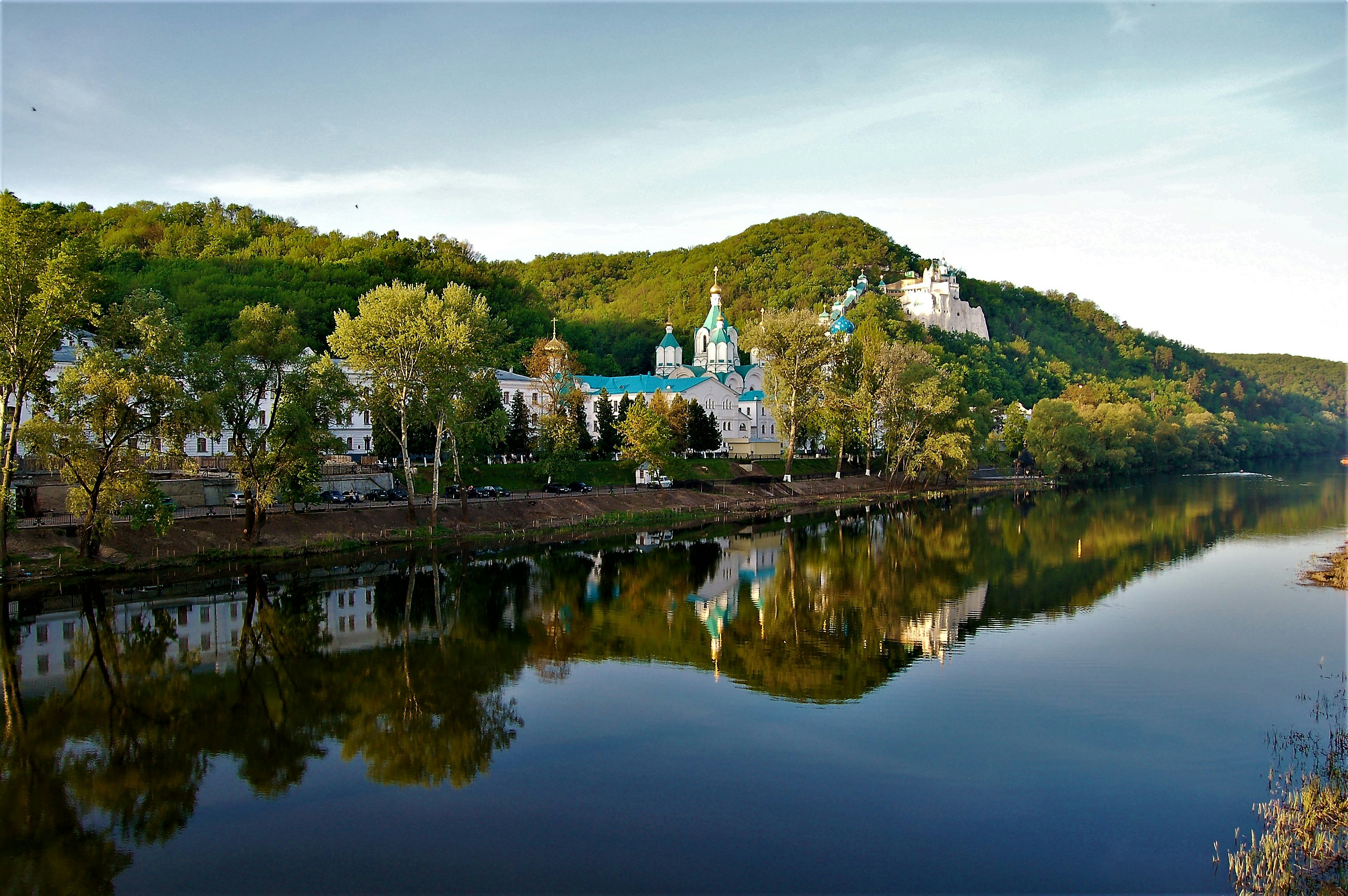 Riverfront Reflections: A Quiet Hilltop Village Basking in Golden Light