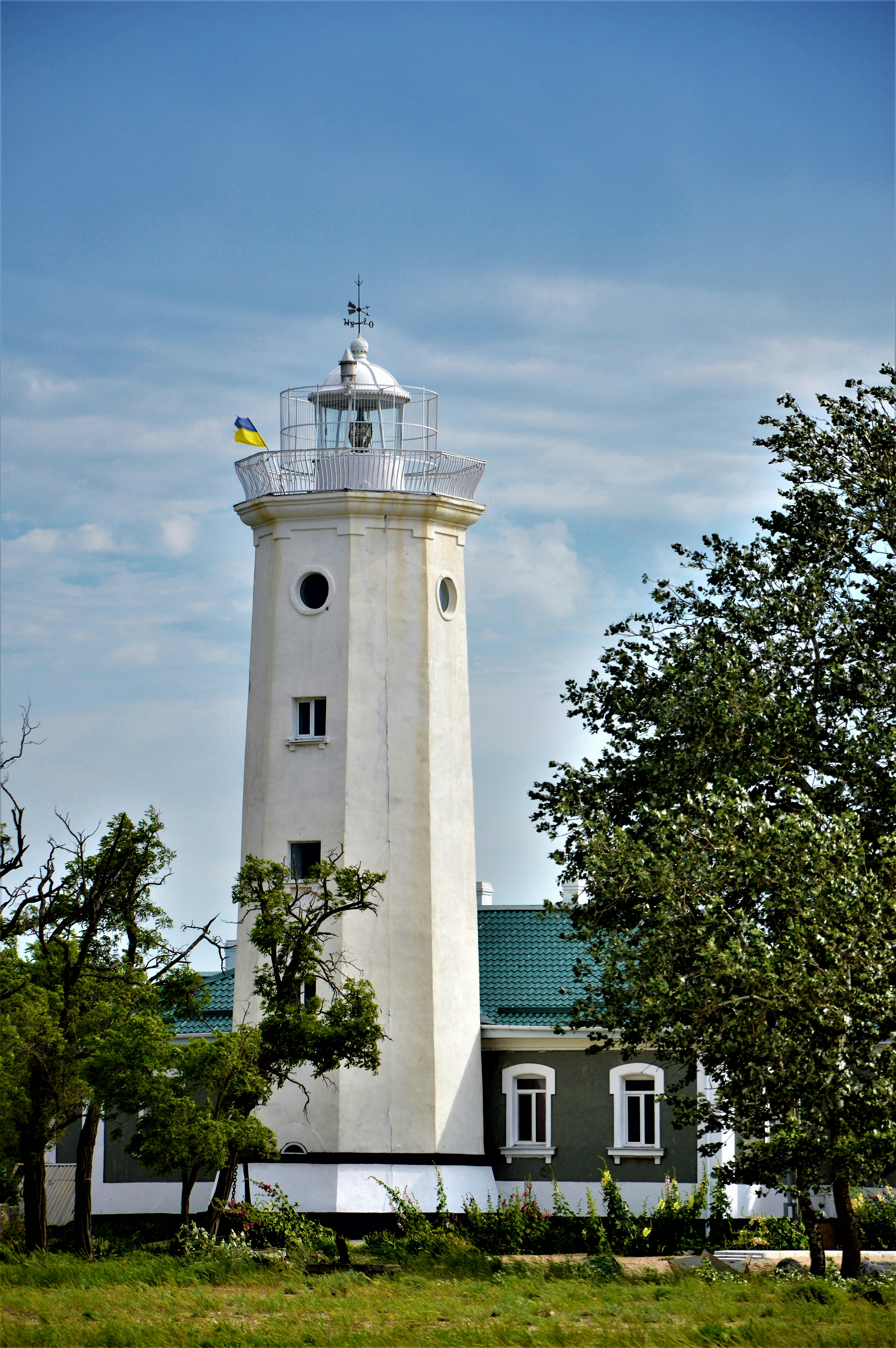 a white tower with a cross on top