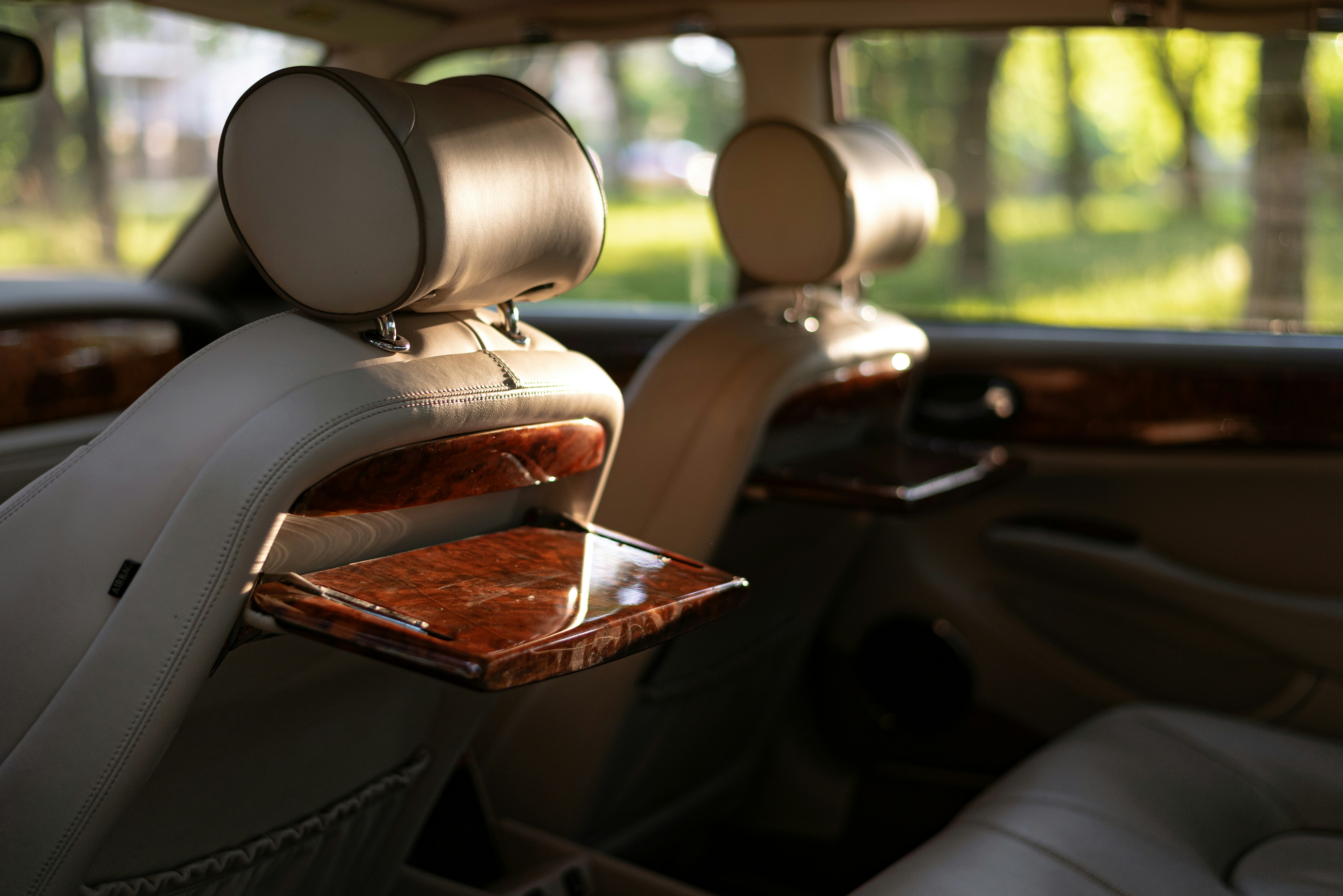 Fold-Down Wood Trays Elevate a Backseat Moment in Luxury Sedan