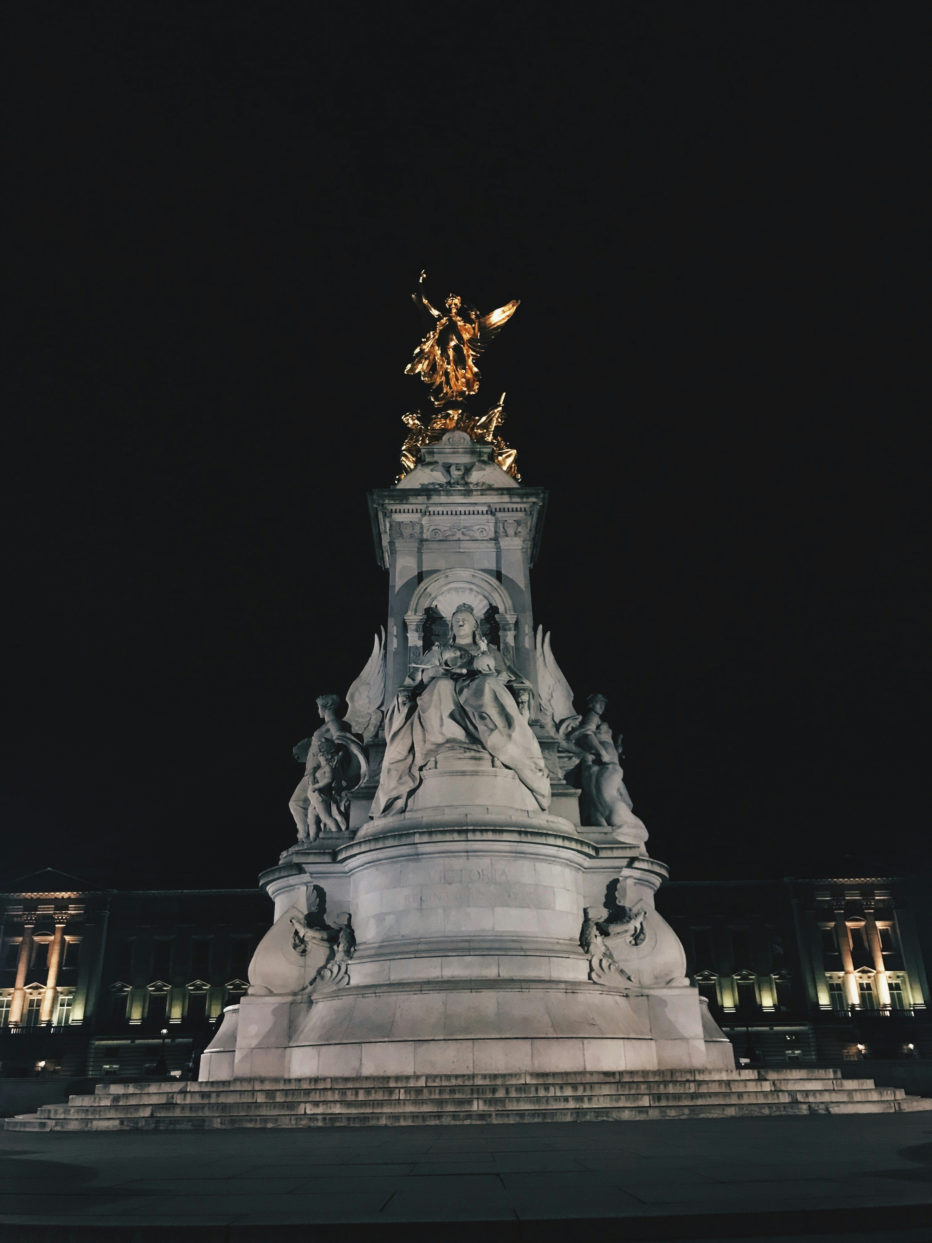 Gold Sentinel at Night: A Marble Monument Piercing the Darkness