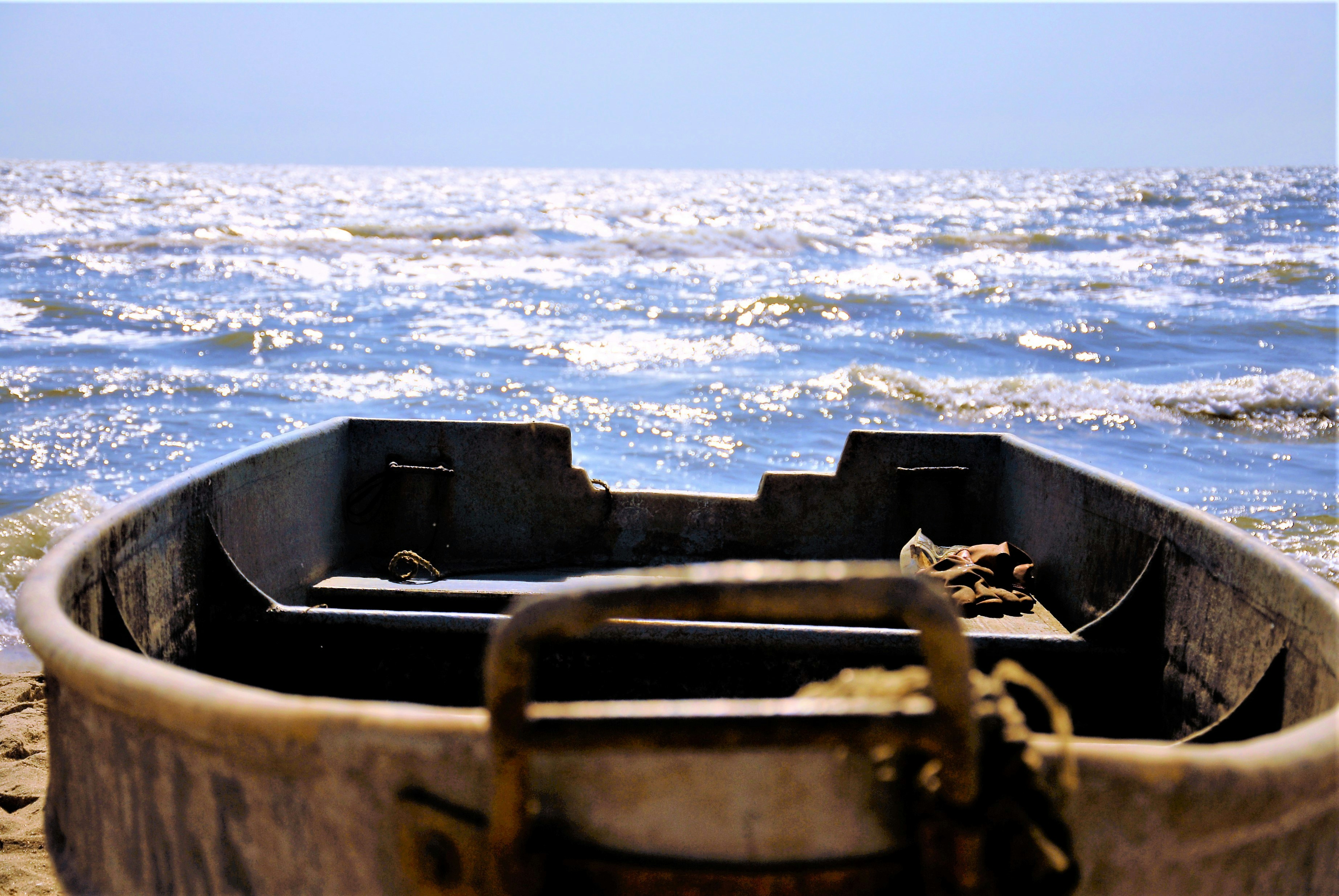 Weathered Rowboat Points Toward the Distant Glimmering Sea