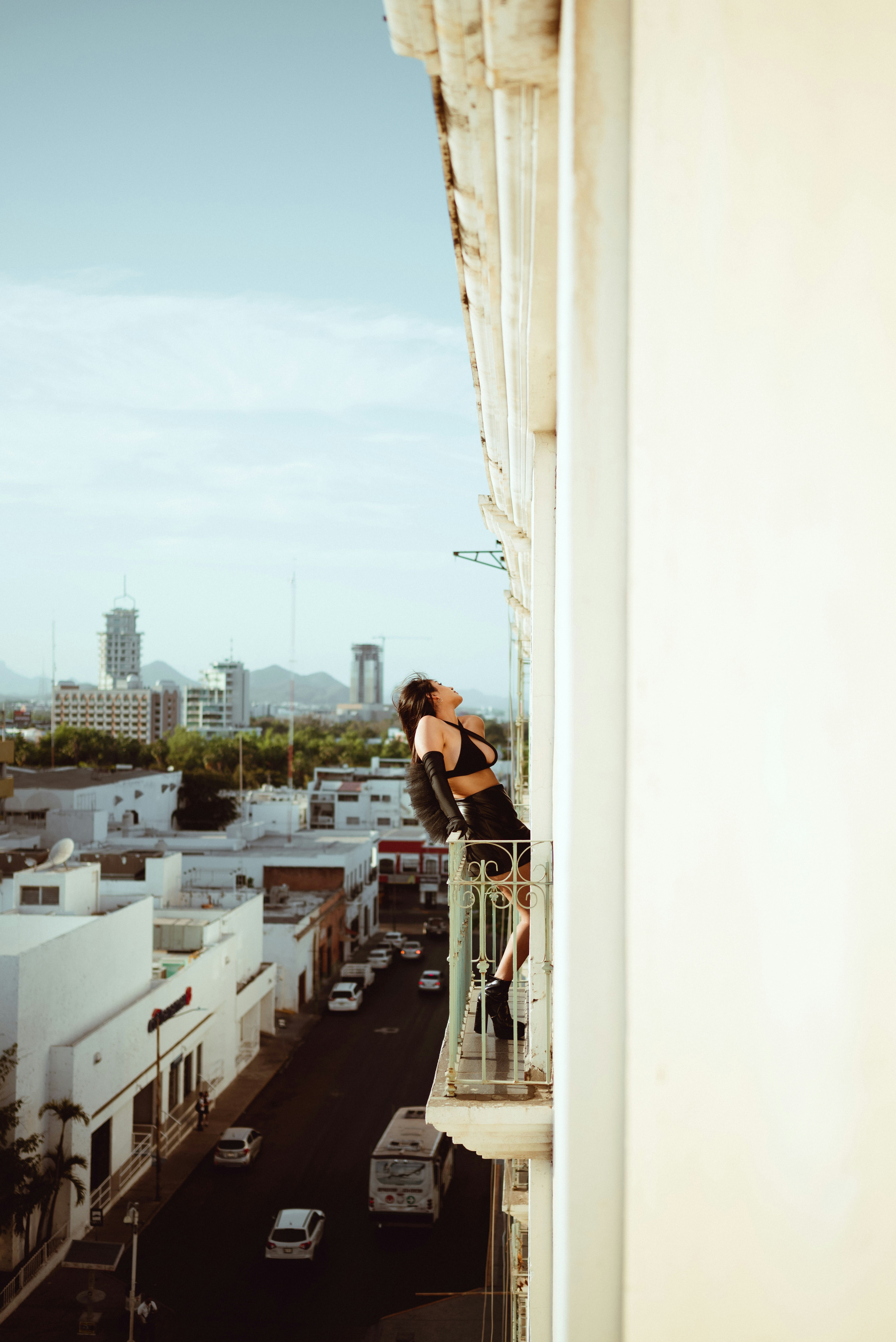 A person standing on a balcony photo – Free Blue Image on Unsplash
