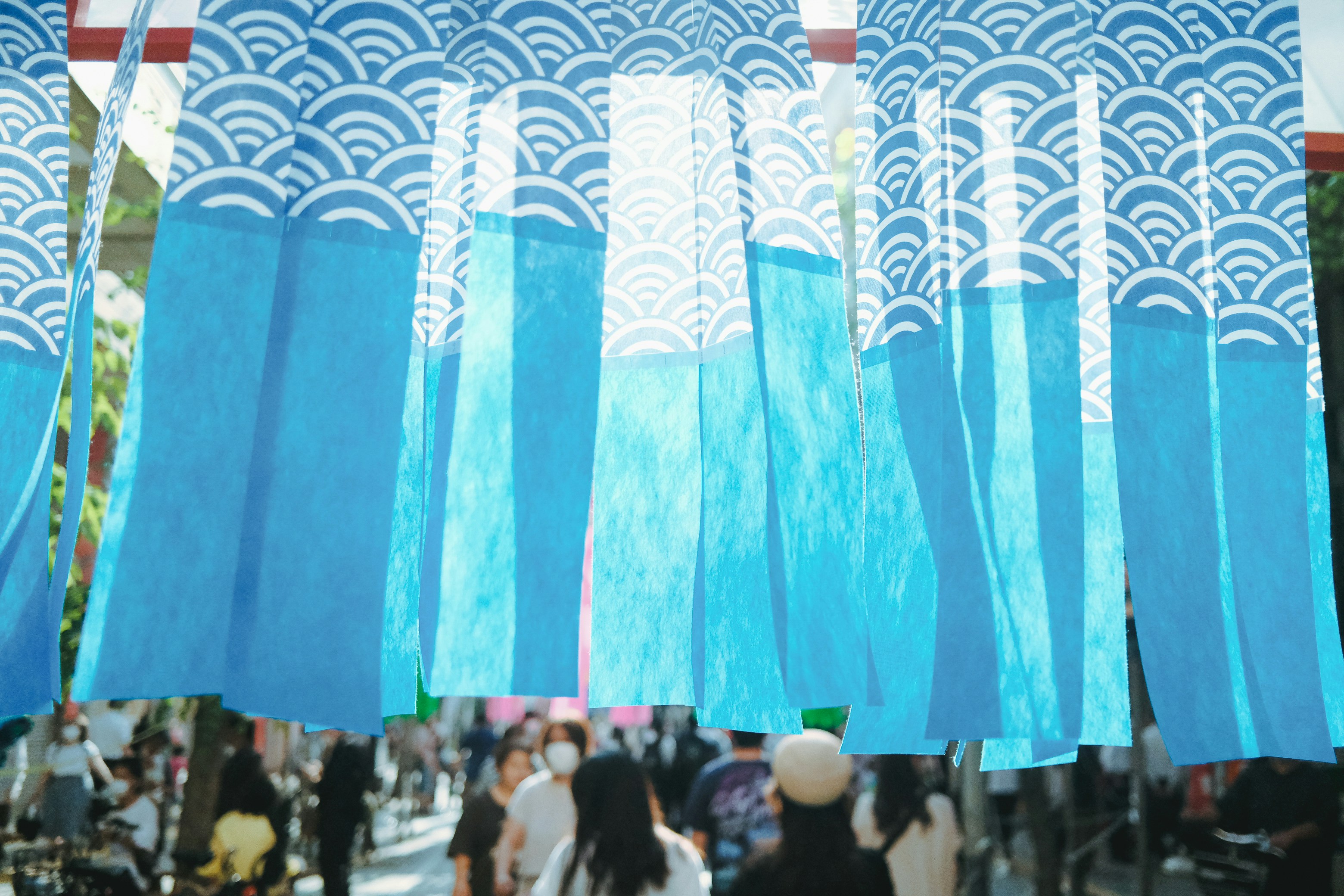 A group of people walking under a blue tarp photo – Free Blue Image on ...