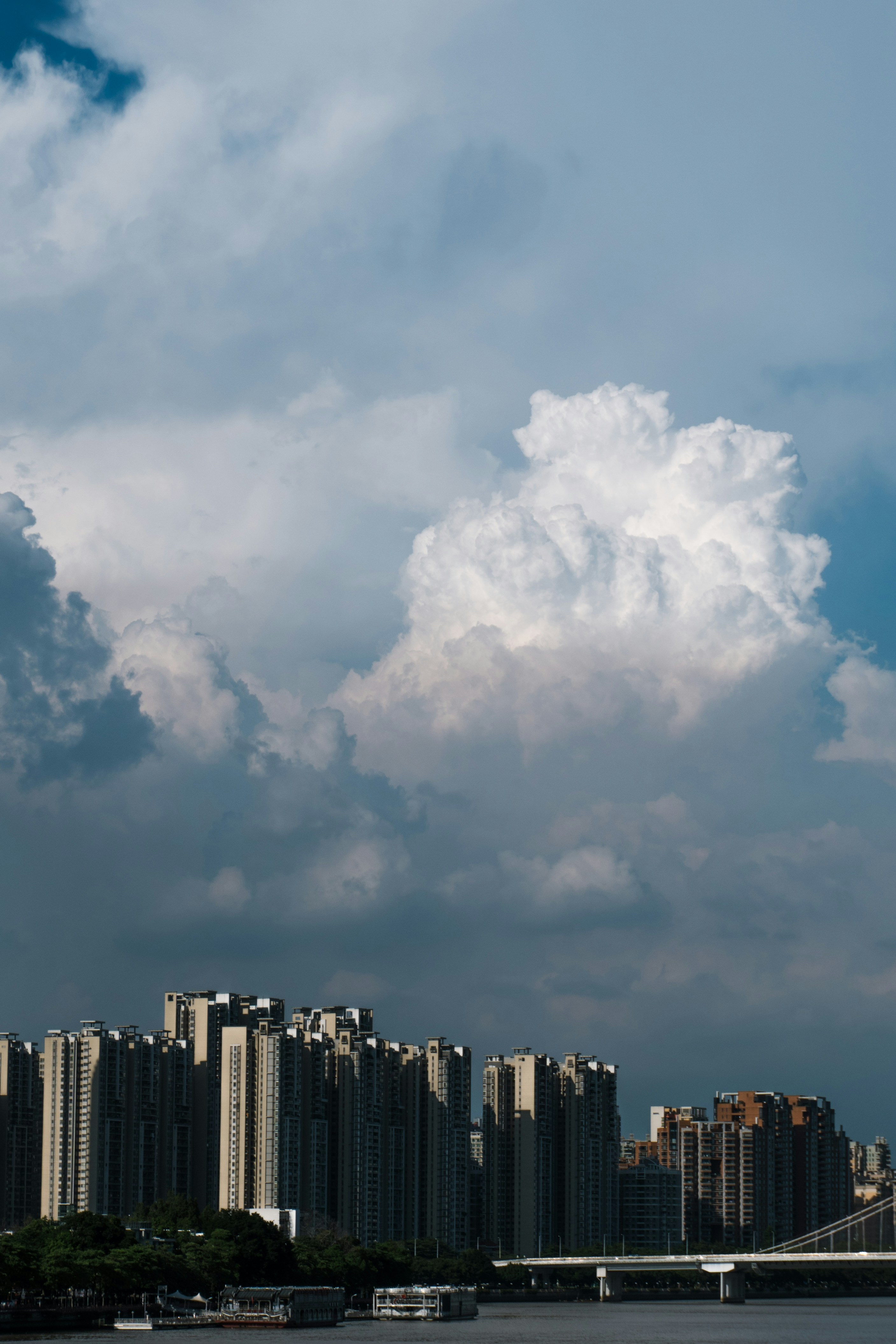 Cumulus Crown Over the Riverfront Cityscape