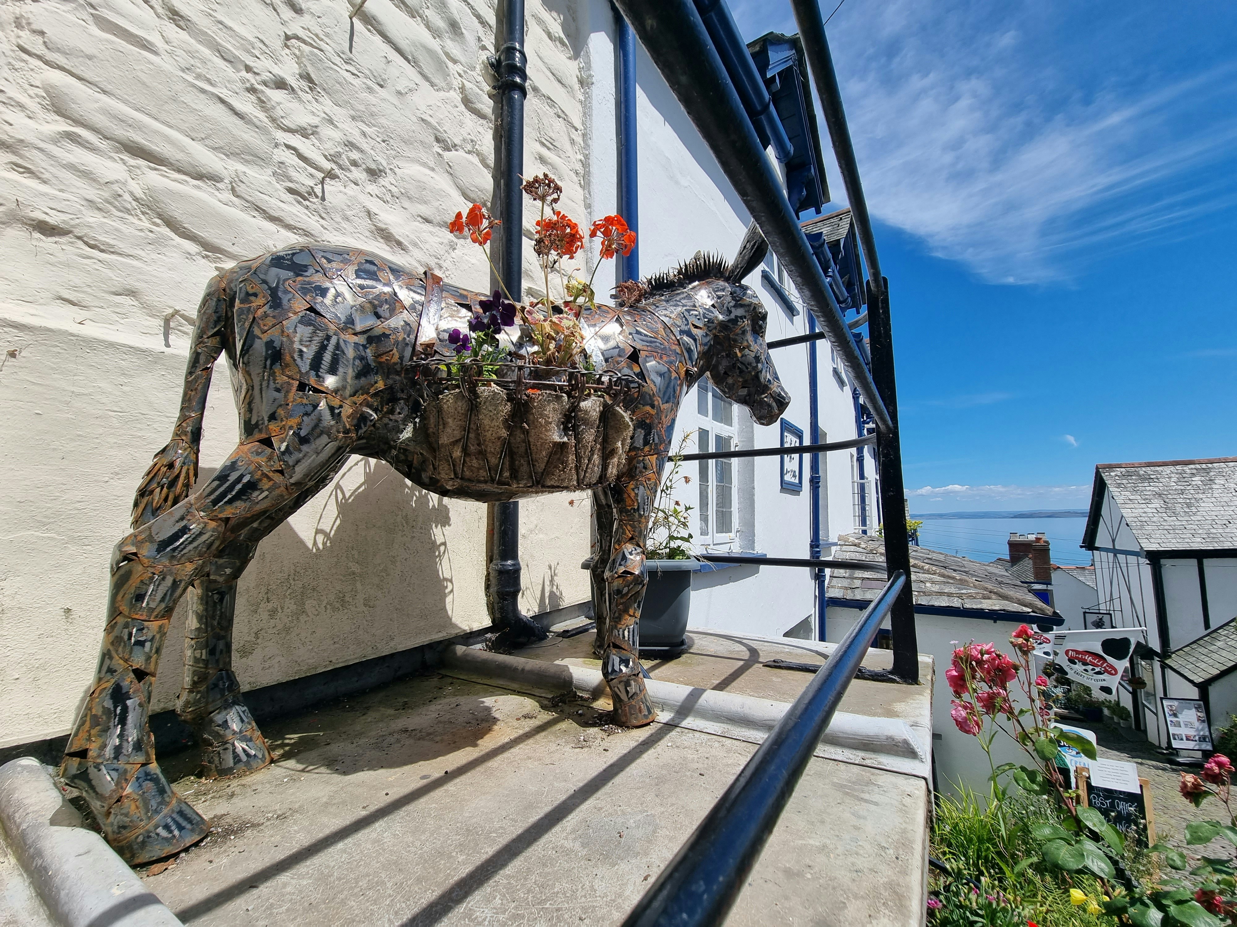 Iron Steed on the Balcony: A Mosaic Horse with Coastal Sky