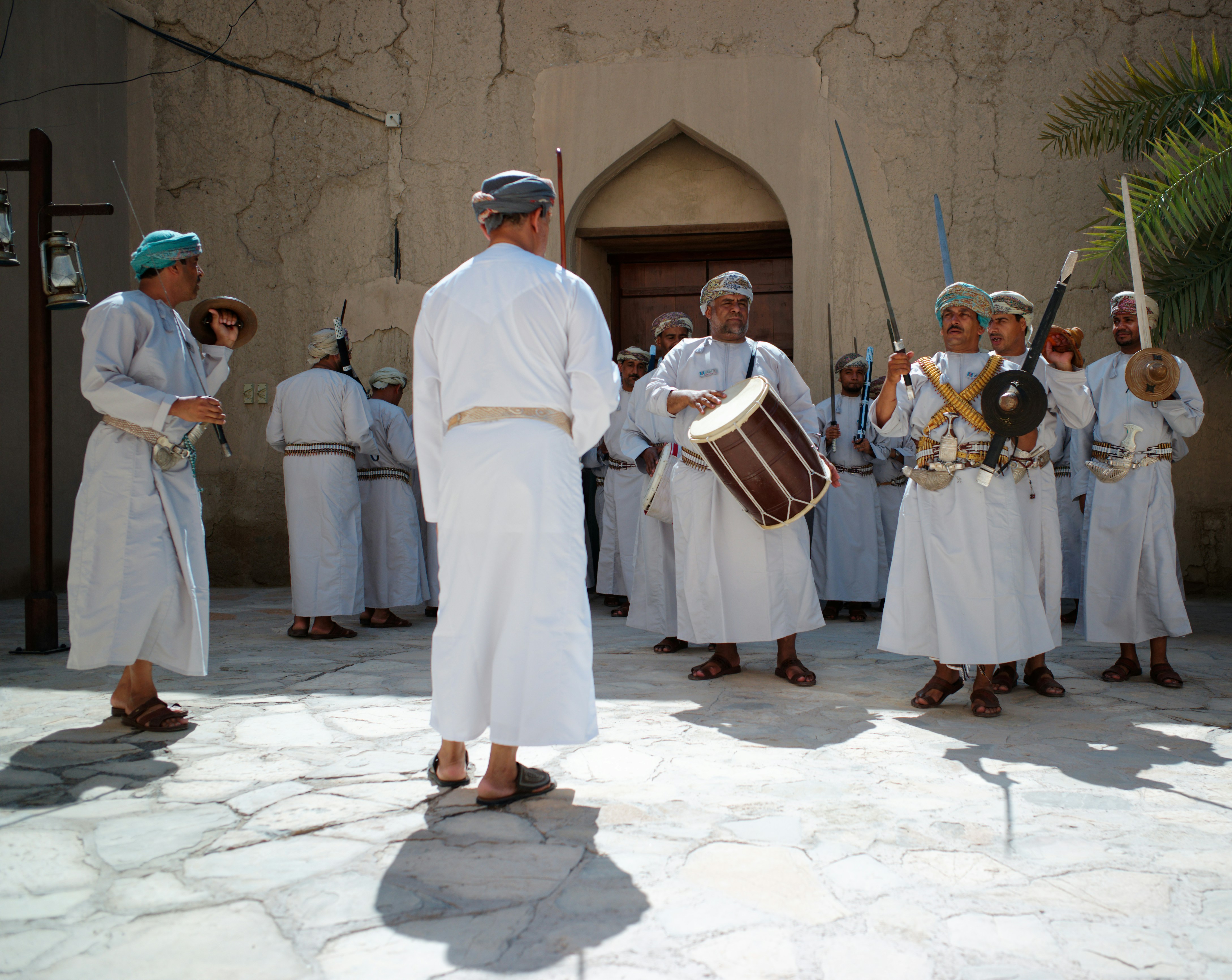 A group of people wearing white robes and holding instruments photo ...