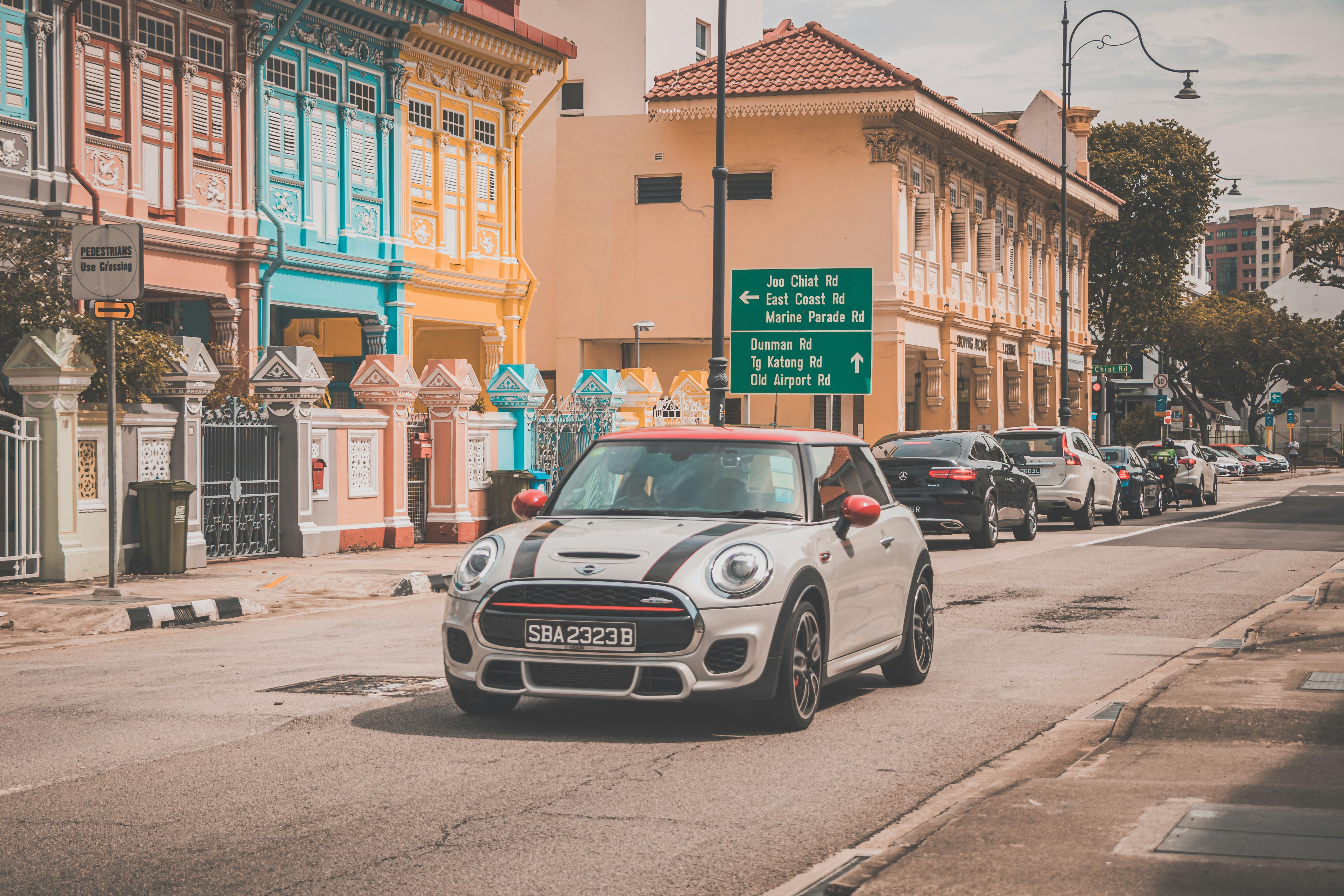 Pastel Shophouses and a White Mini Cooper on a Sunlit Street