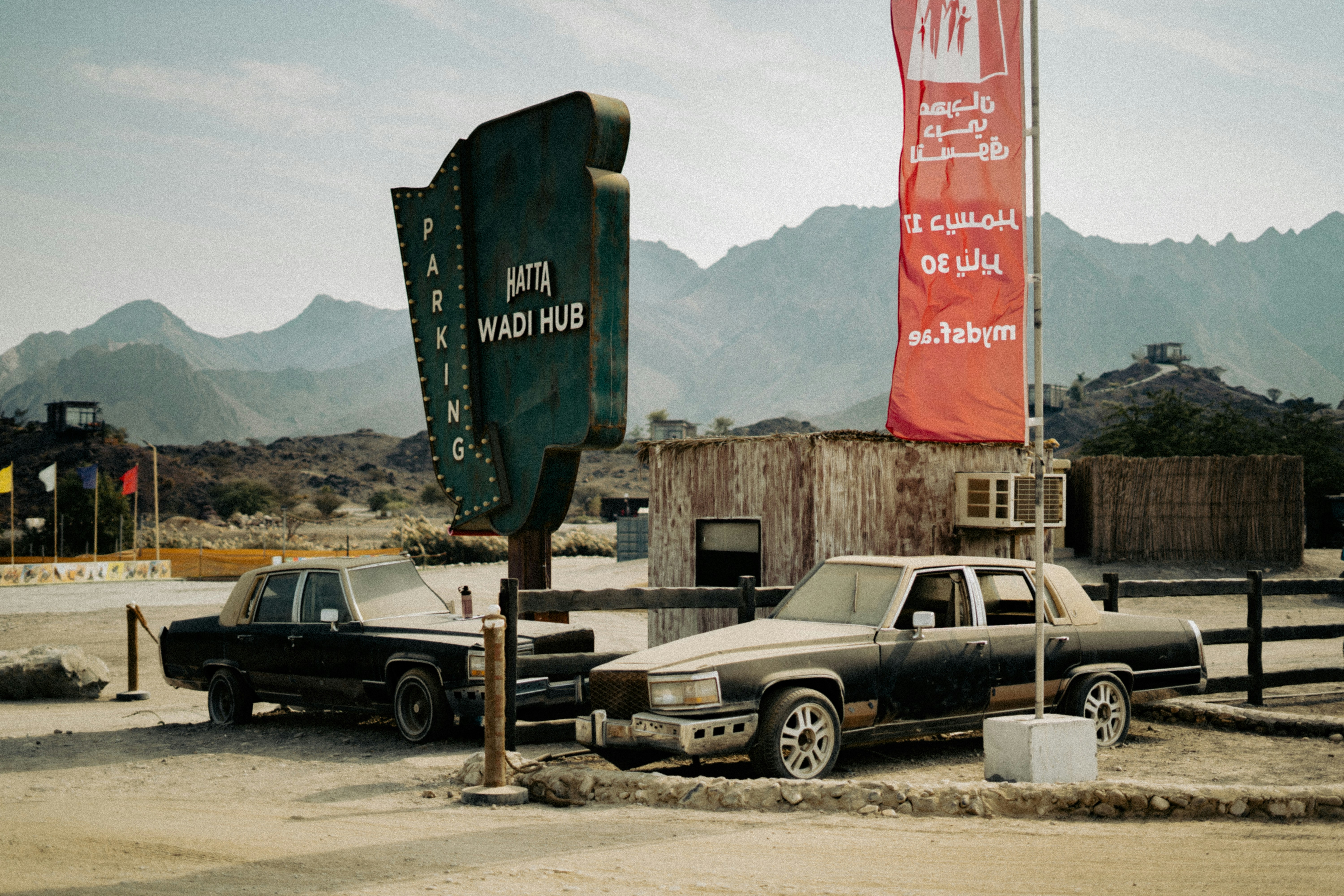 Rusted Rigs and a Lone Parking Sign in a Desert Frontier