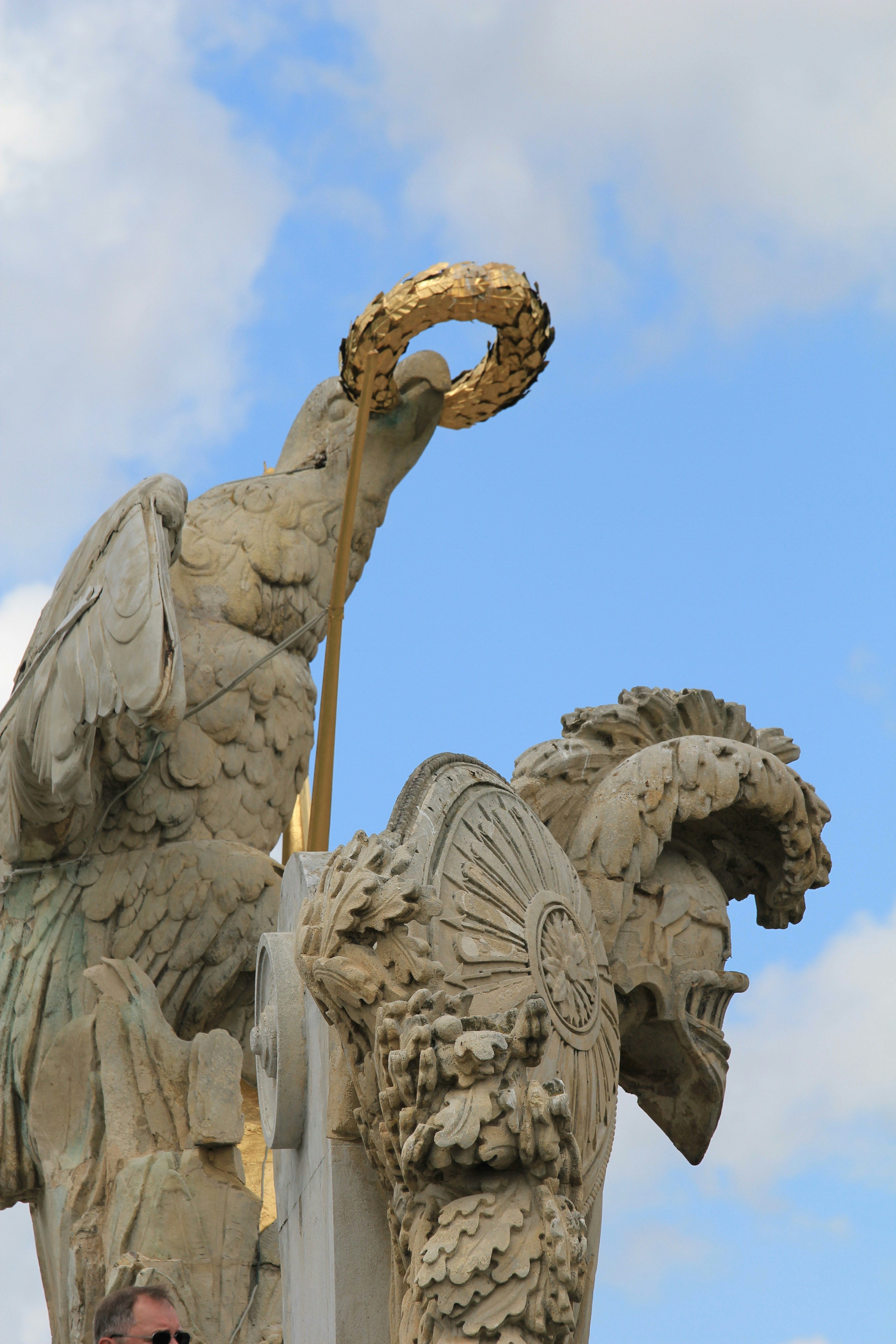 Winged Sentinel Under a Gilded Halo Against a Clear Sky
