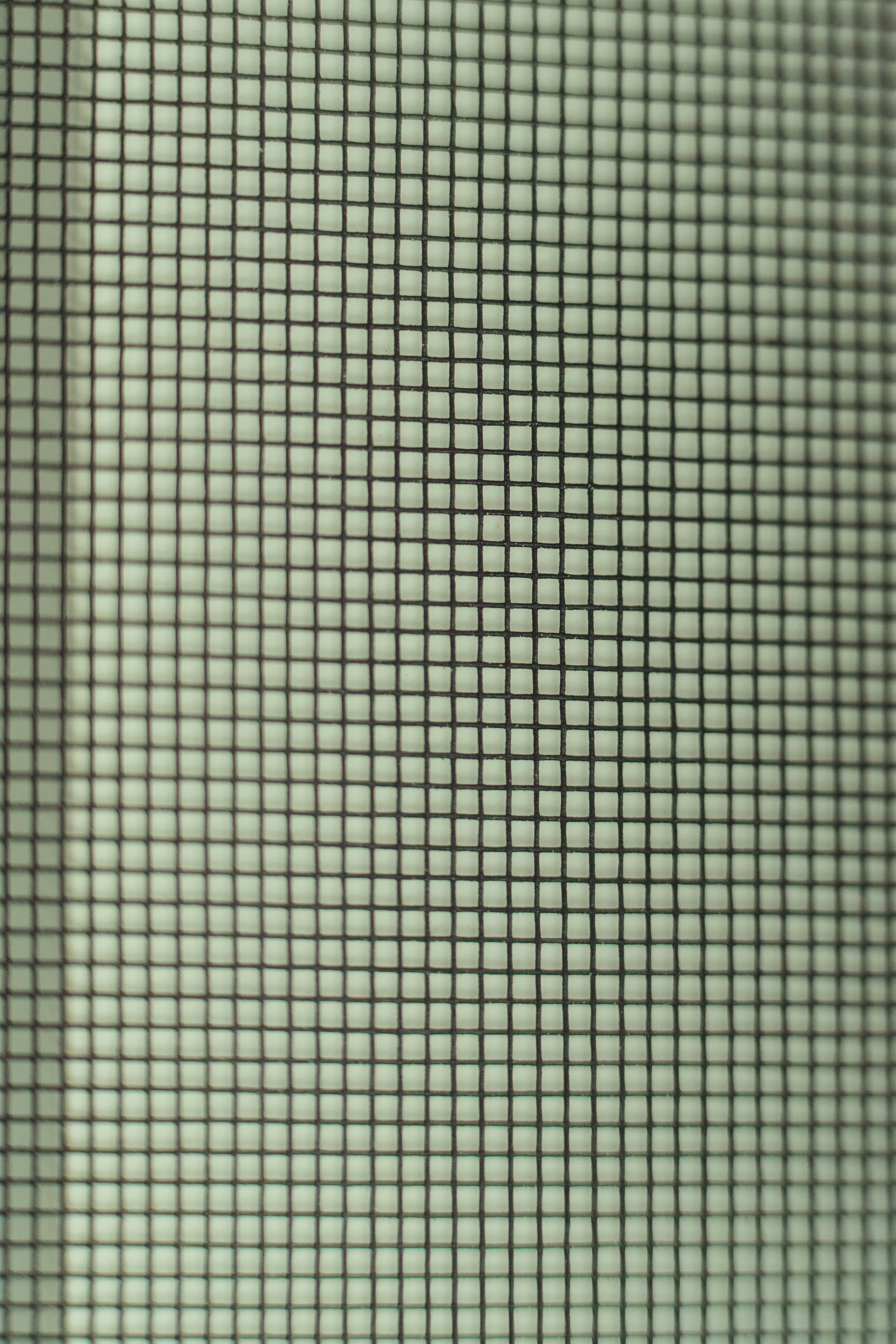 Close-up of a fine mesh pattern, showcasing the meticulous arrangement of its grid structure.