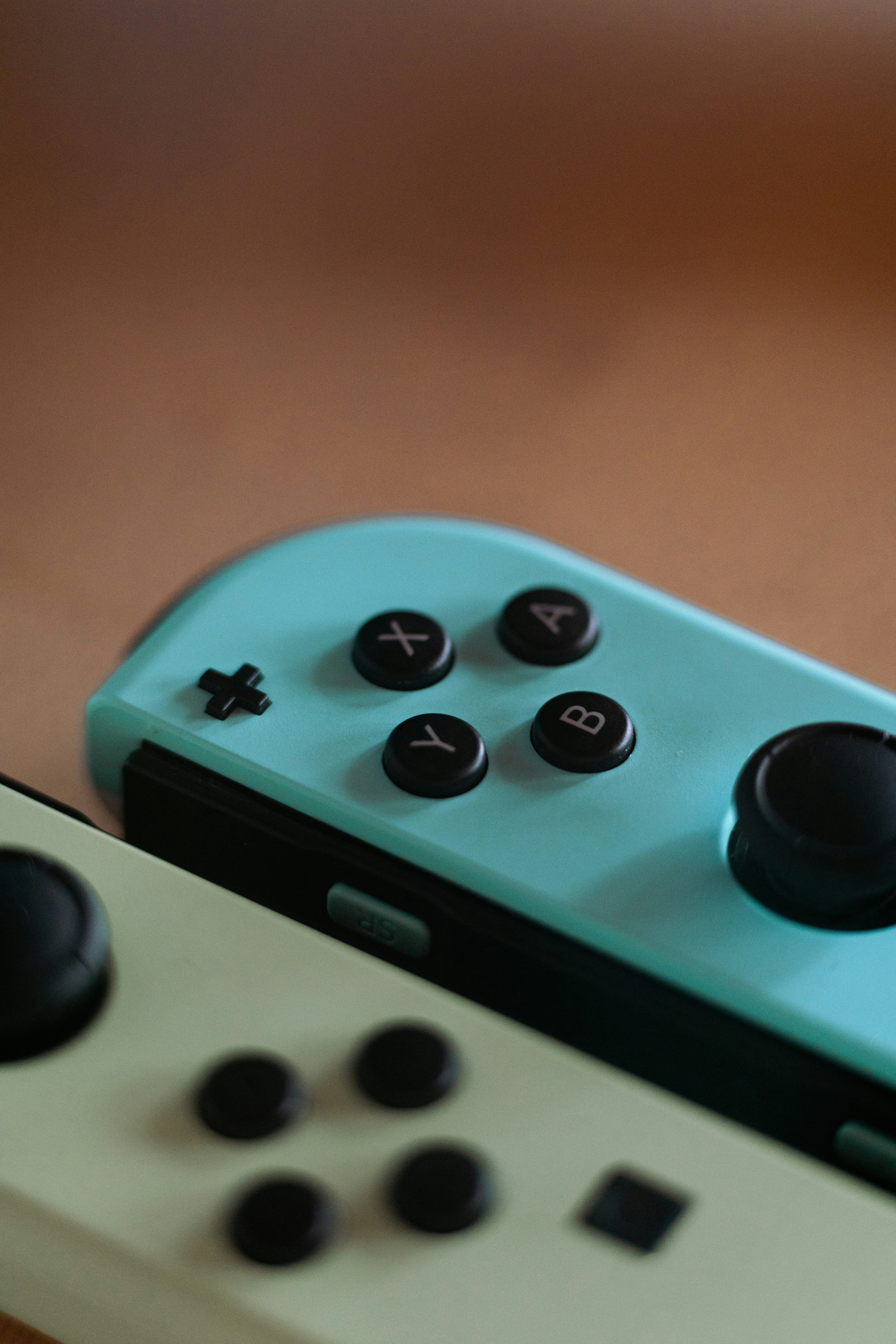 Close-up of two gaming controllers, highlighting the vibrant buttons and ergonomic design. The image captures the essence of modern gaming accessories.