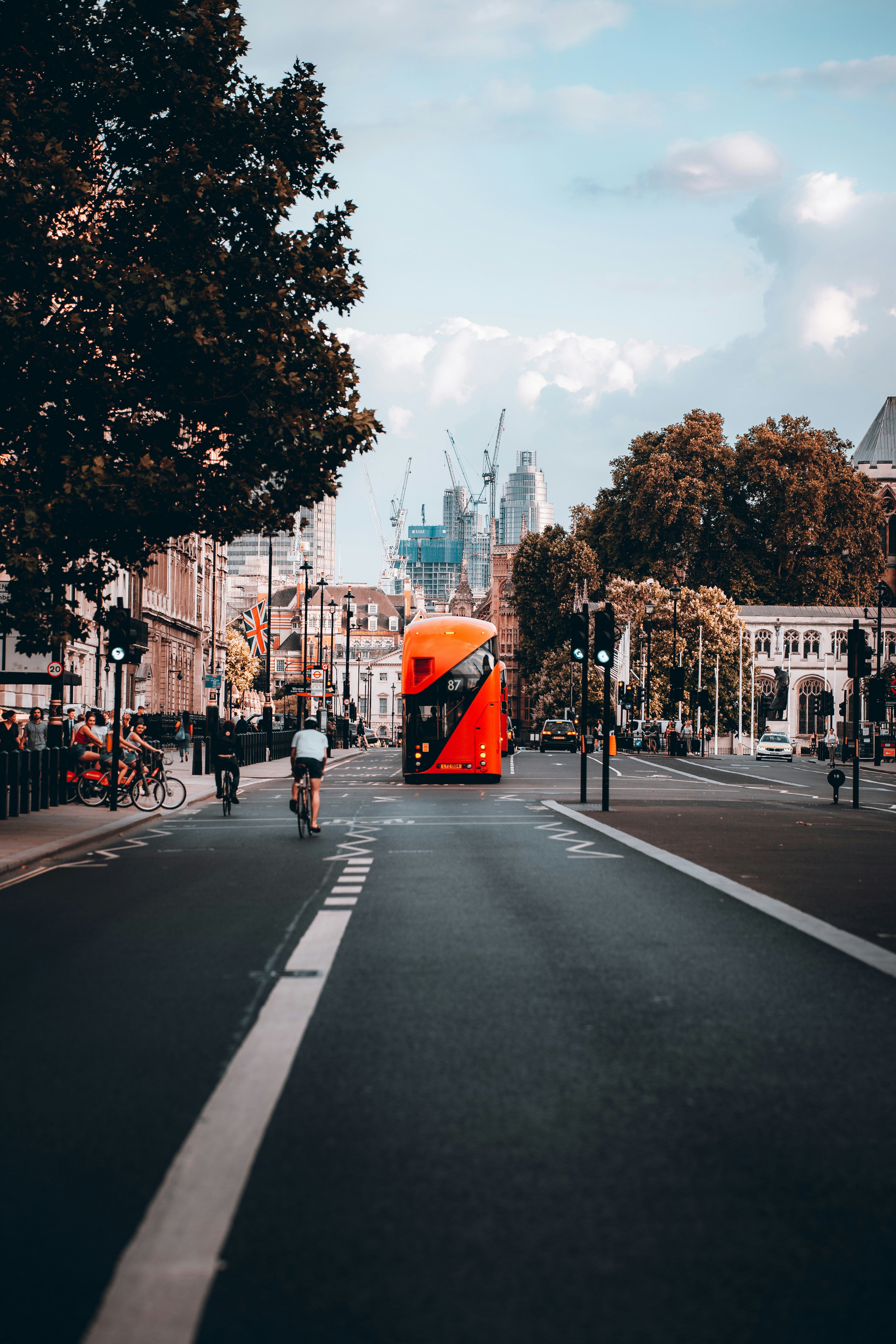 Urban Pulse: The Red Tram Anchoring a Narrow City Street