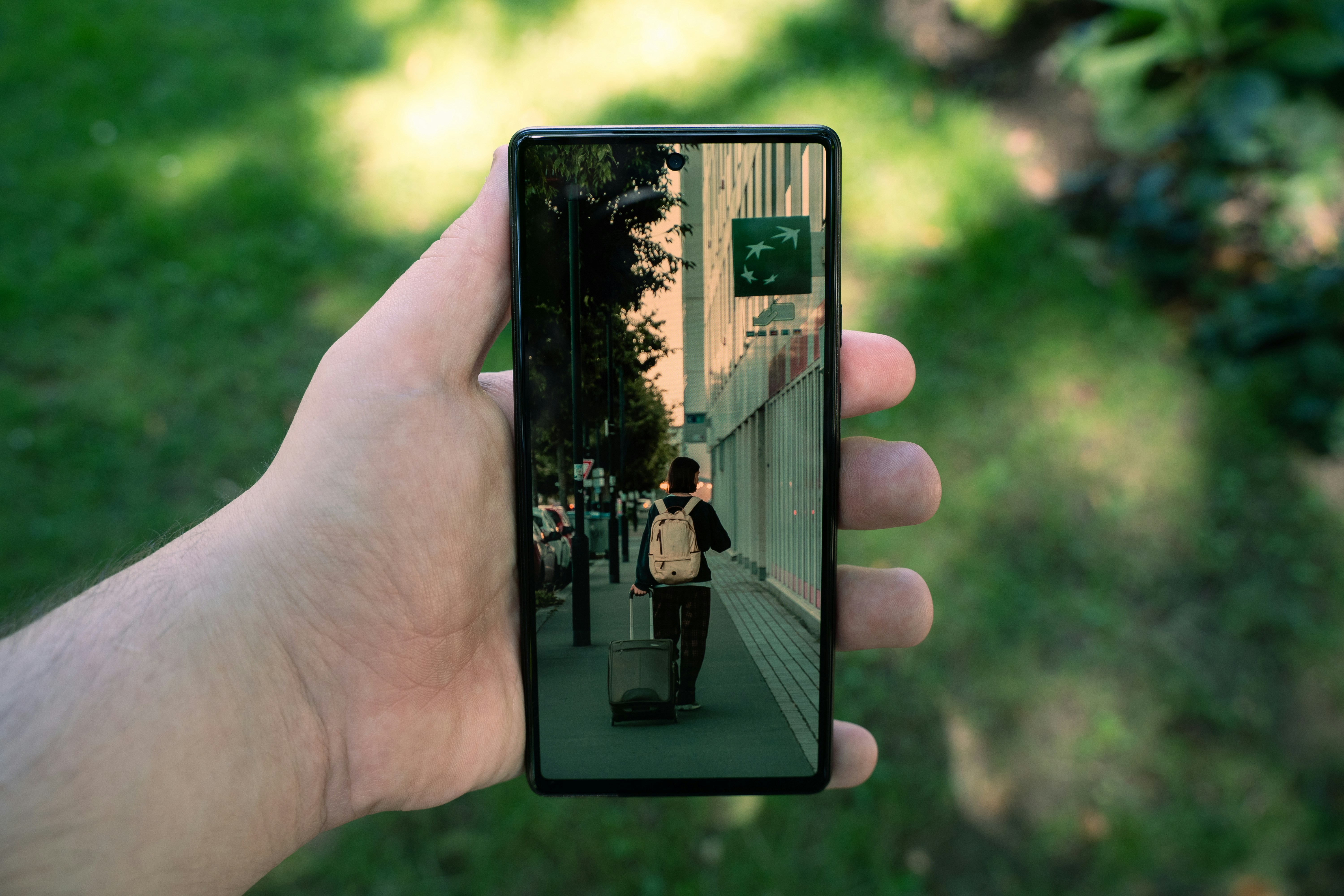 Through a Pocket Window: a Traveler with a Rolling Case in Focus
