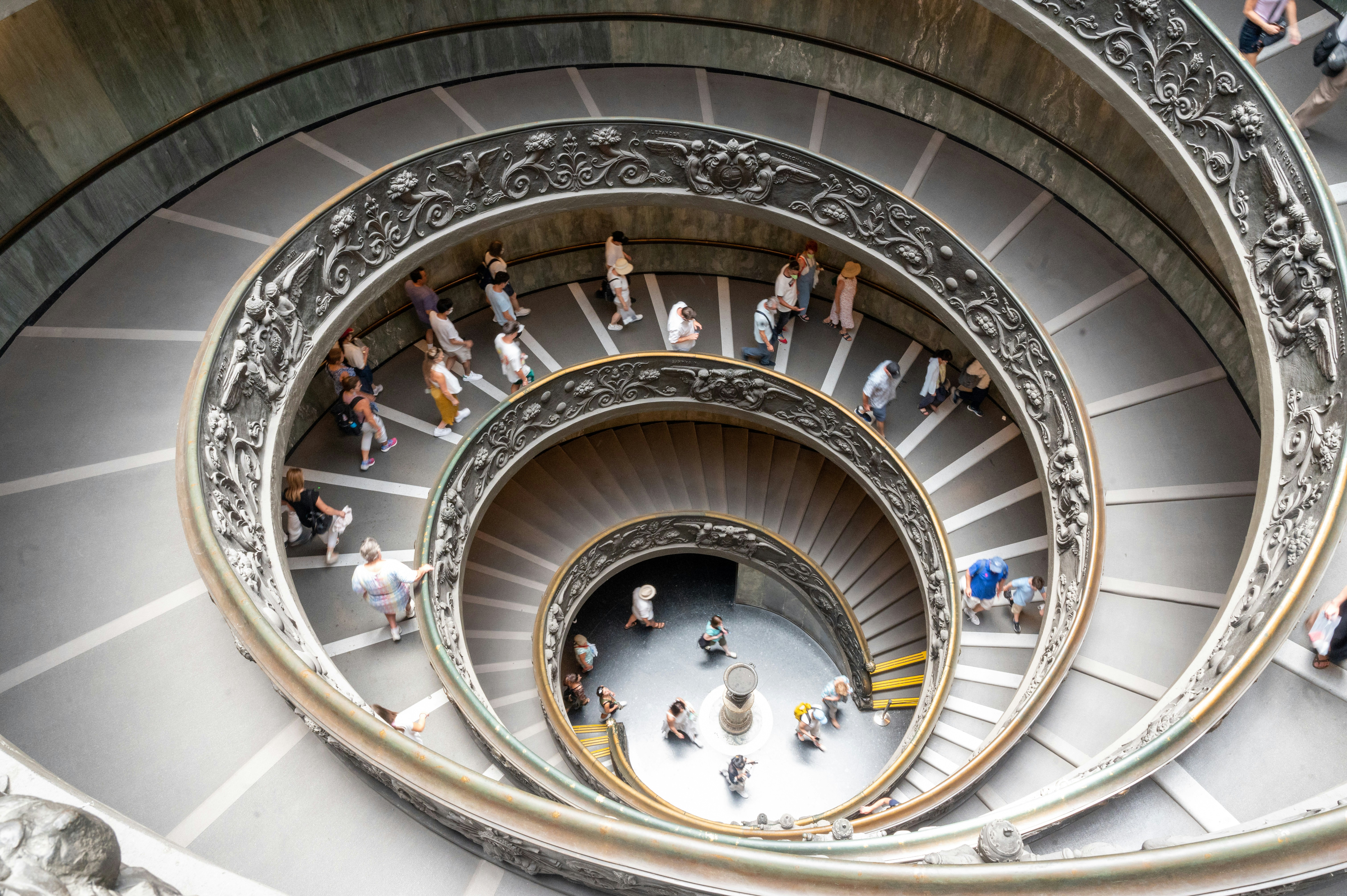 A Vortex of Steps: People Threading the Sands of an Ornate Spiral