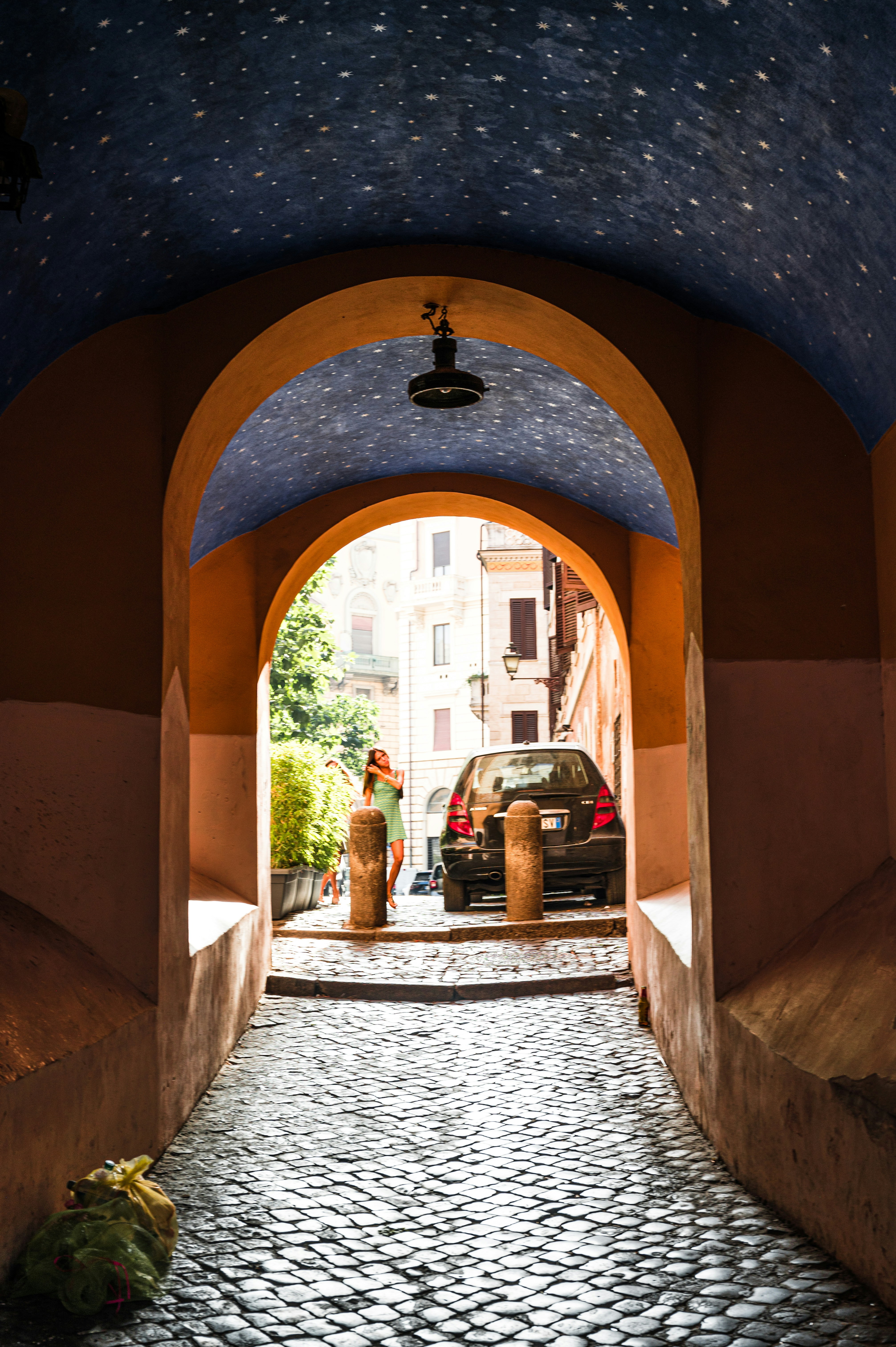 A stone walkway with a car parked in the middle photo – Free ...