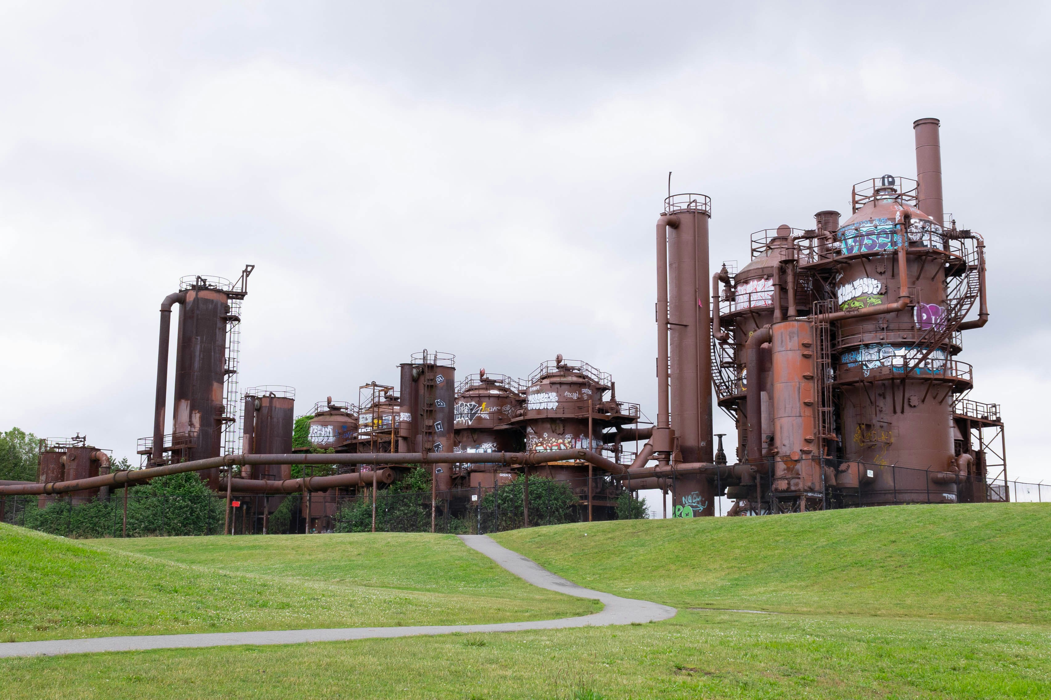 Iron Colossi Over the Green Knoll: A Quiet Industrial Vista