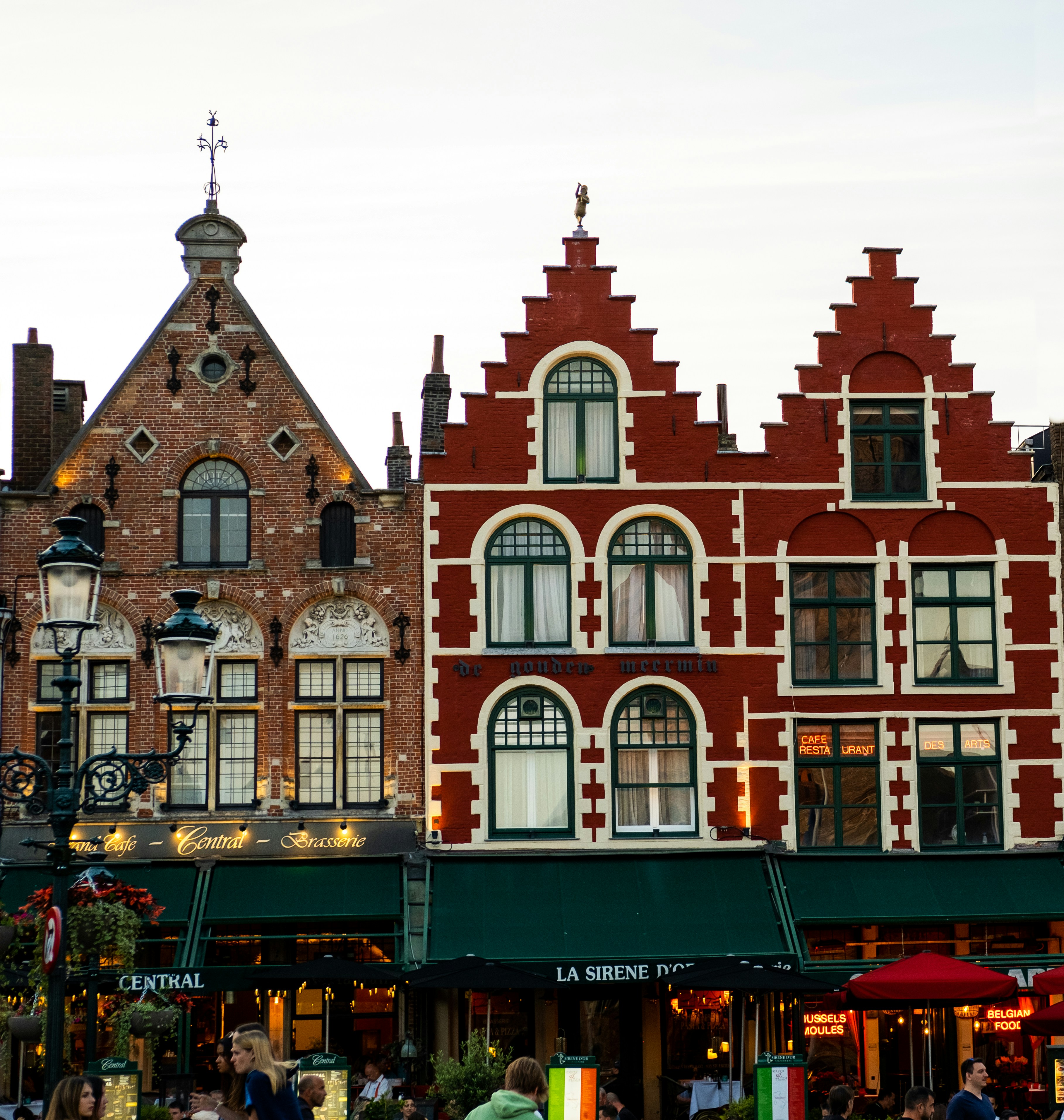 A group of buildings with people walking around photo – Free Brugge ...
