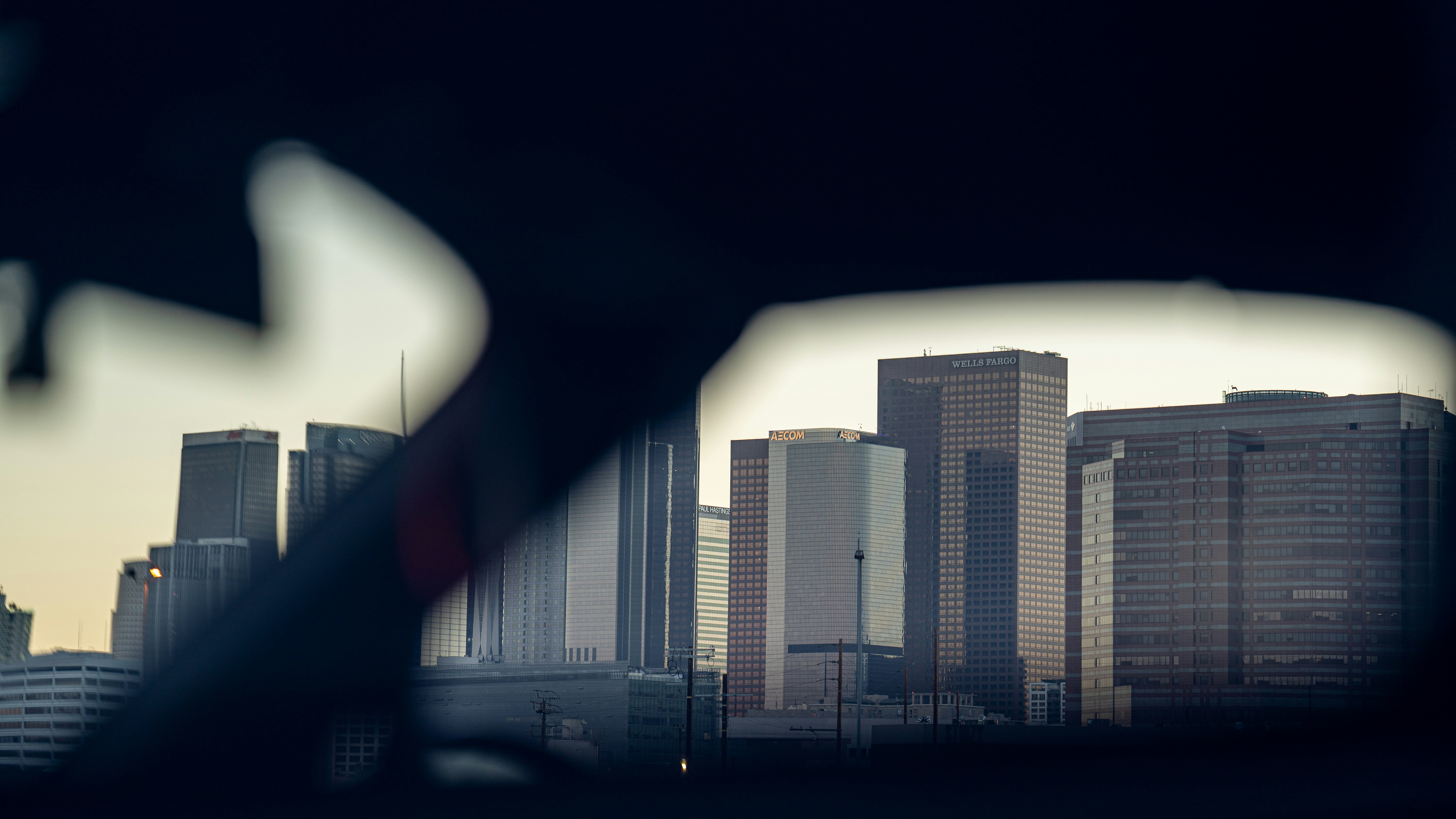 a hand holding a light up to a group of buildings