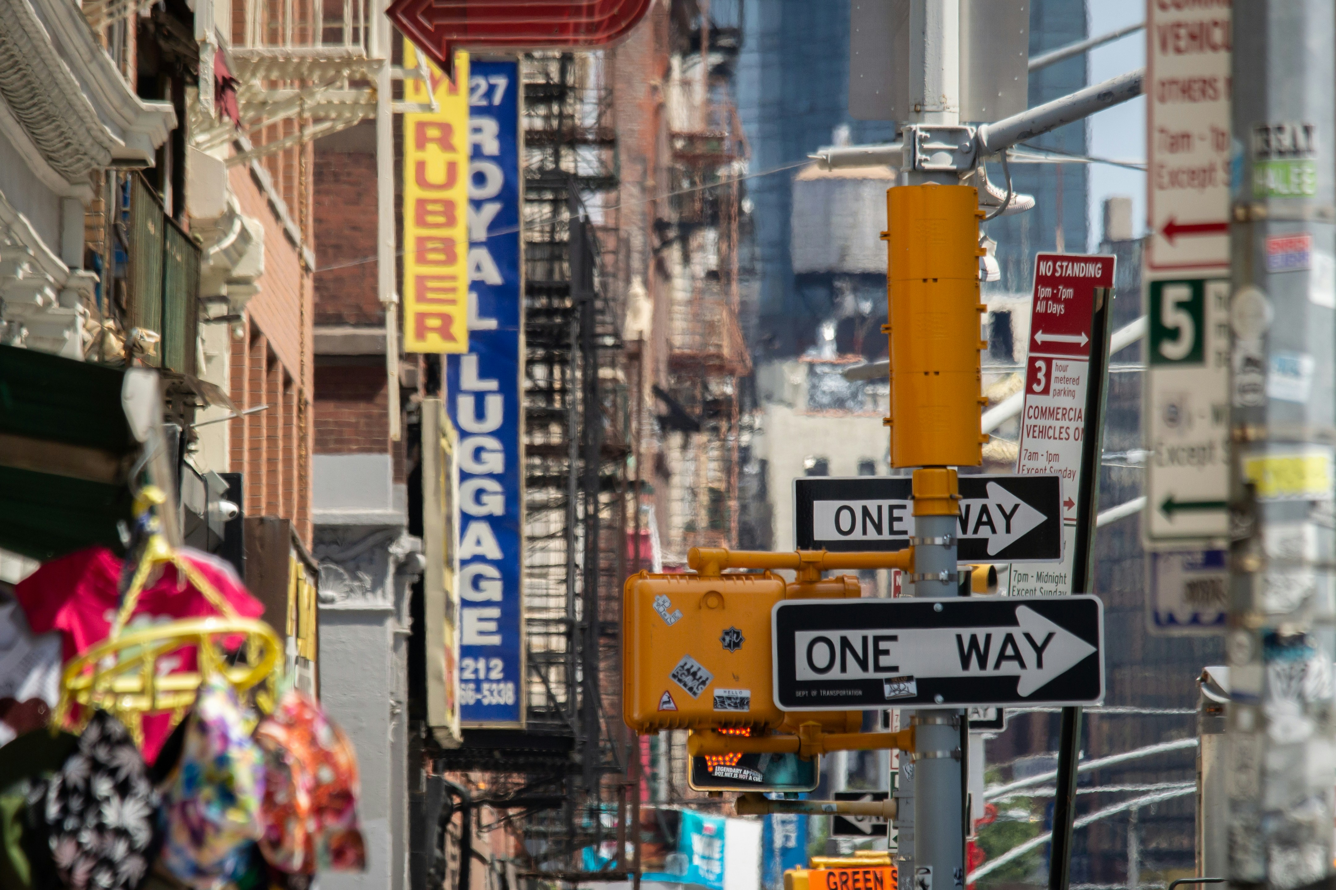 Street signs and vintage storefronts converge in a bustling urban scene, highlighting the vibrant character of city life.