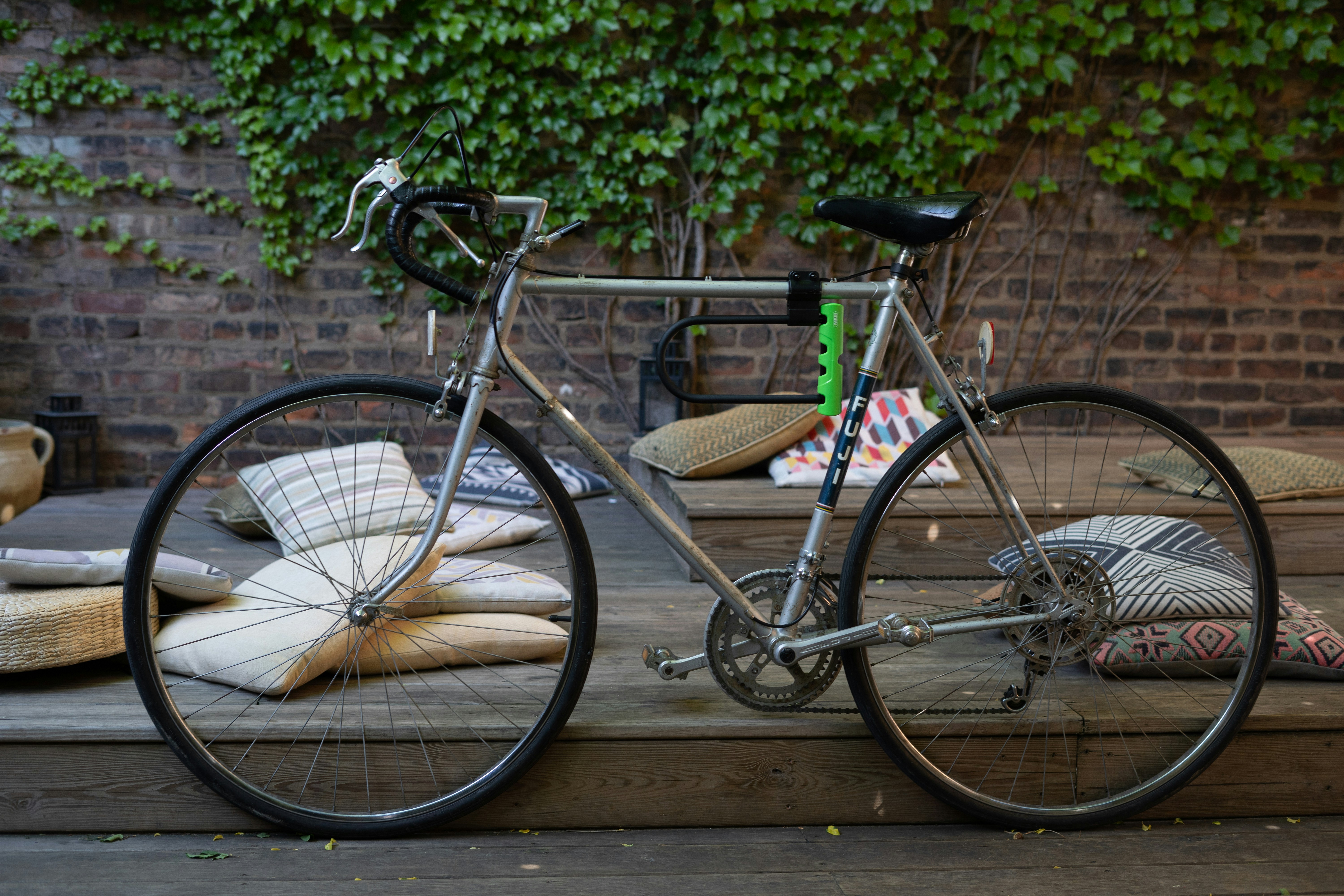 Vintage steel bicycle resting on a sunlit wooden deck