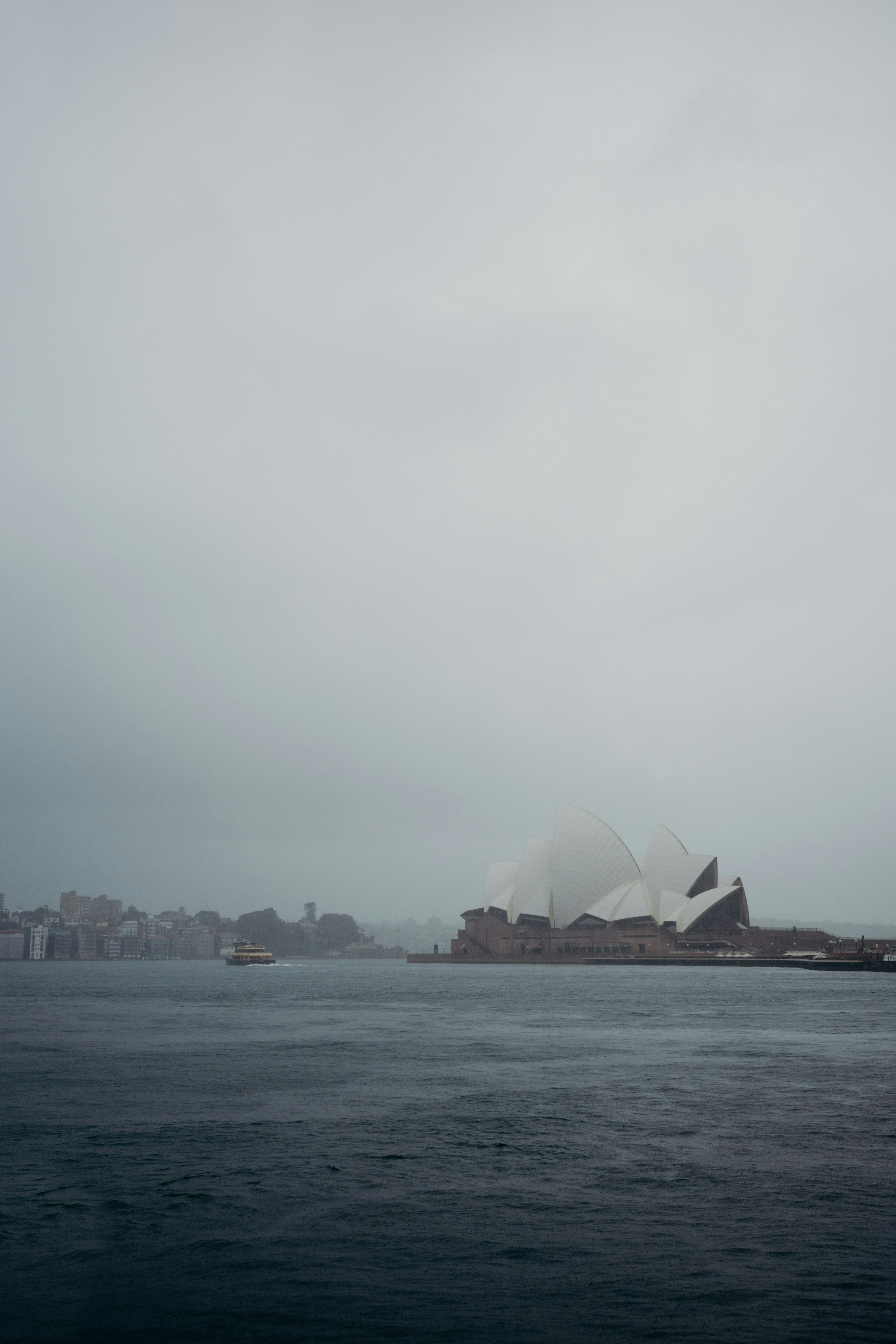 Harbor in the Mist: Sydney Opera House Emerges Through a Grey Sky