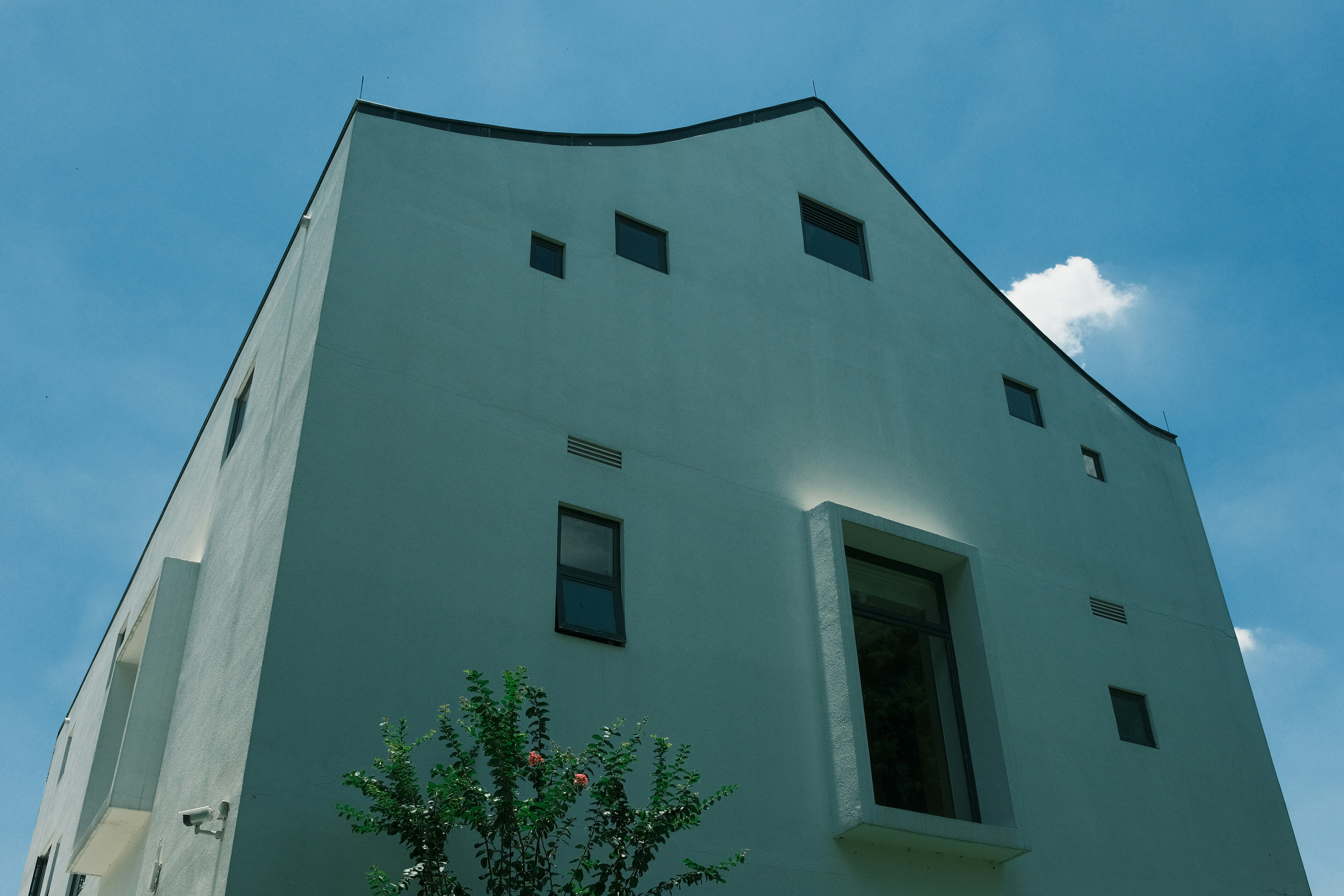 Azure Facade: A Corner Tower Framed by a Crisp Blue Sky