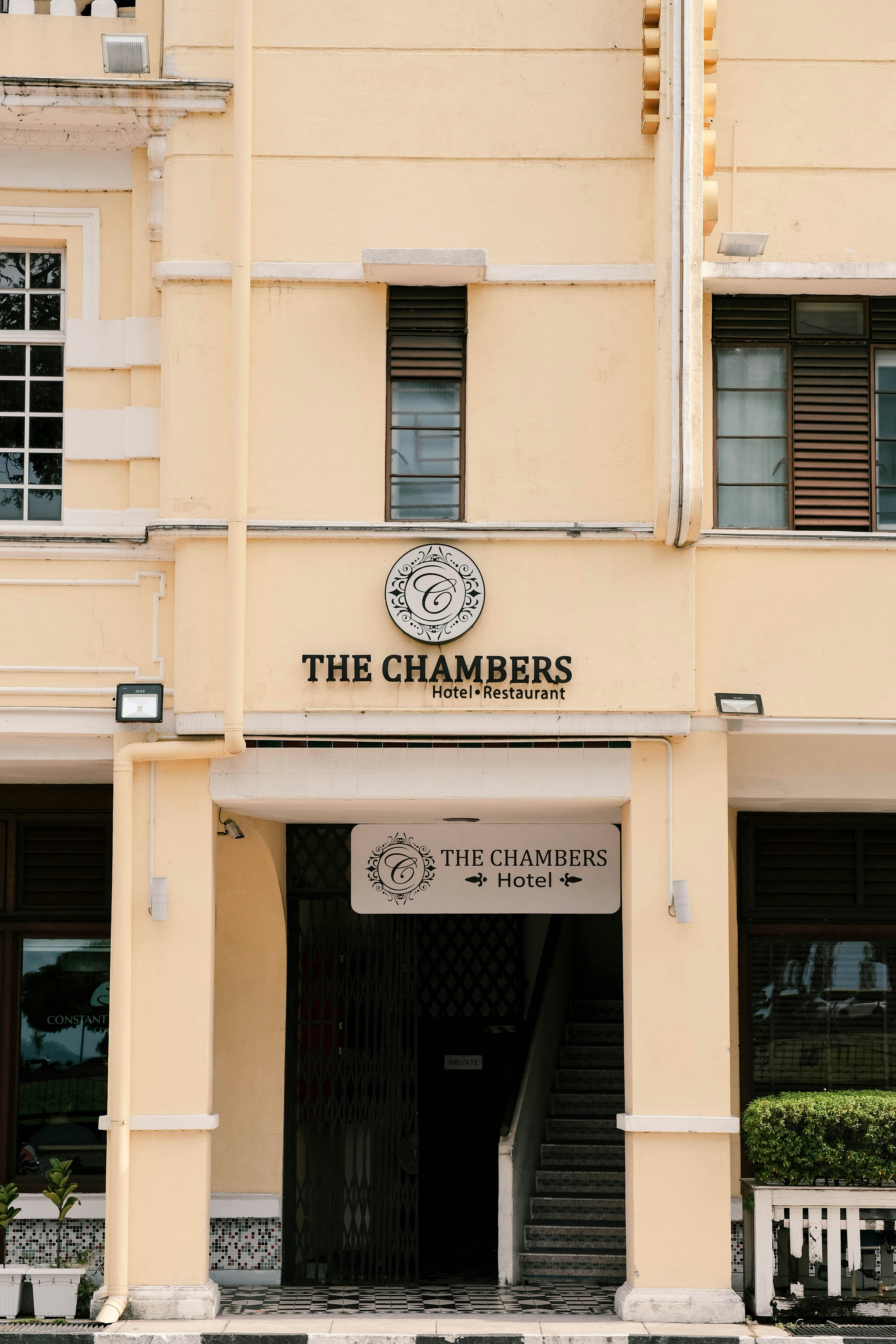 Elegant entrance of The Chambers Hotel and Restaurant, showcasing a blend of architectural charm and inviting ambiance.