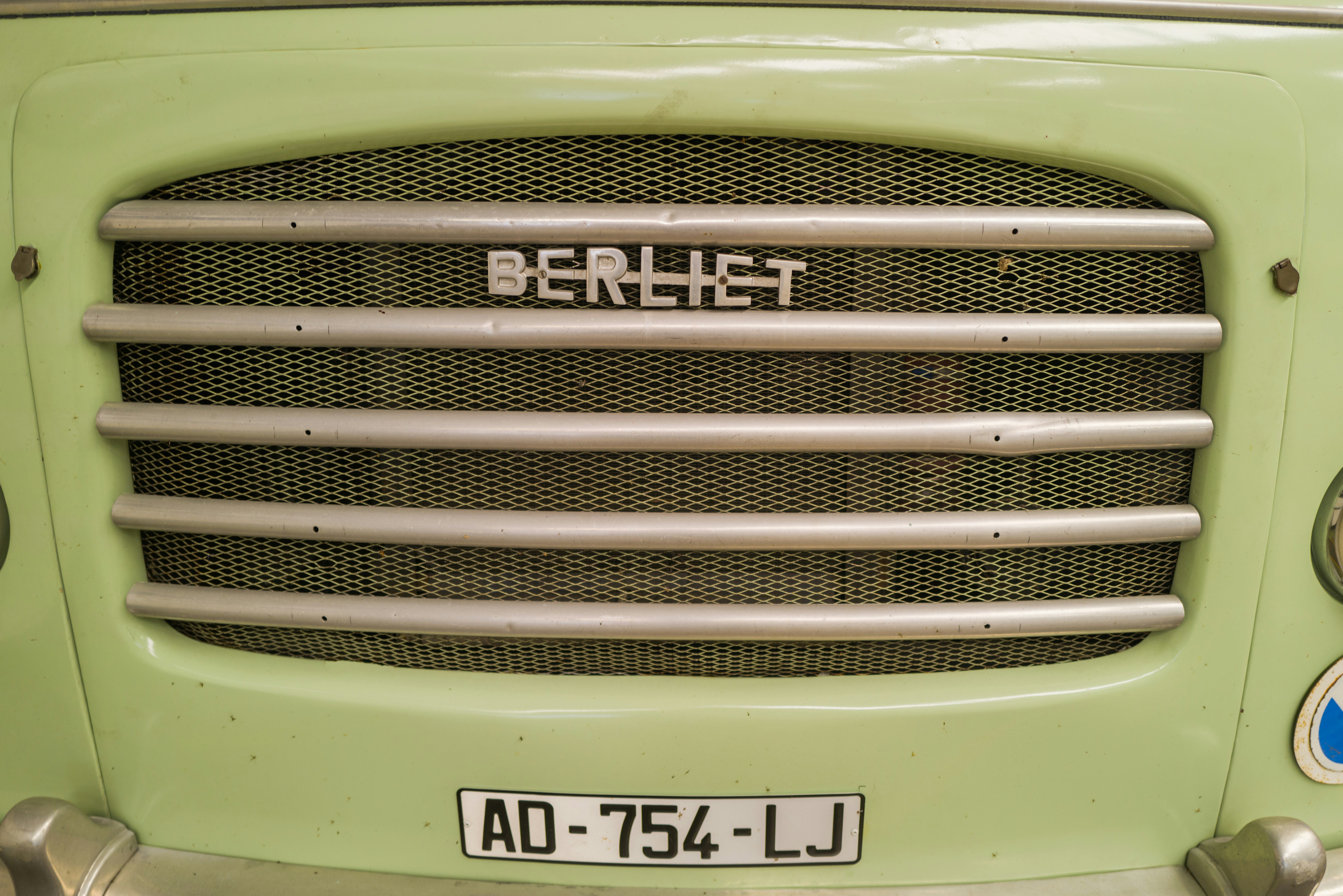 Emerald Berliet Front Grille: Weathered Chrome on a Vintage Truck
