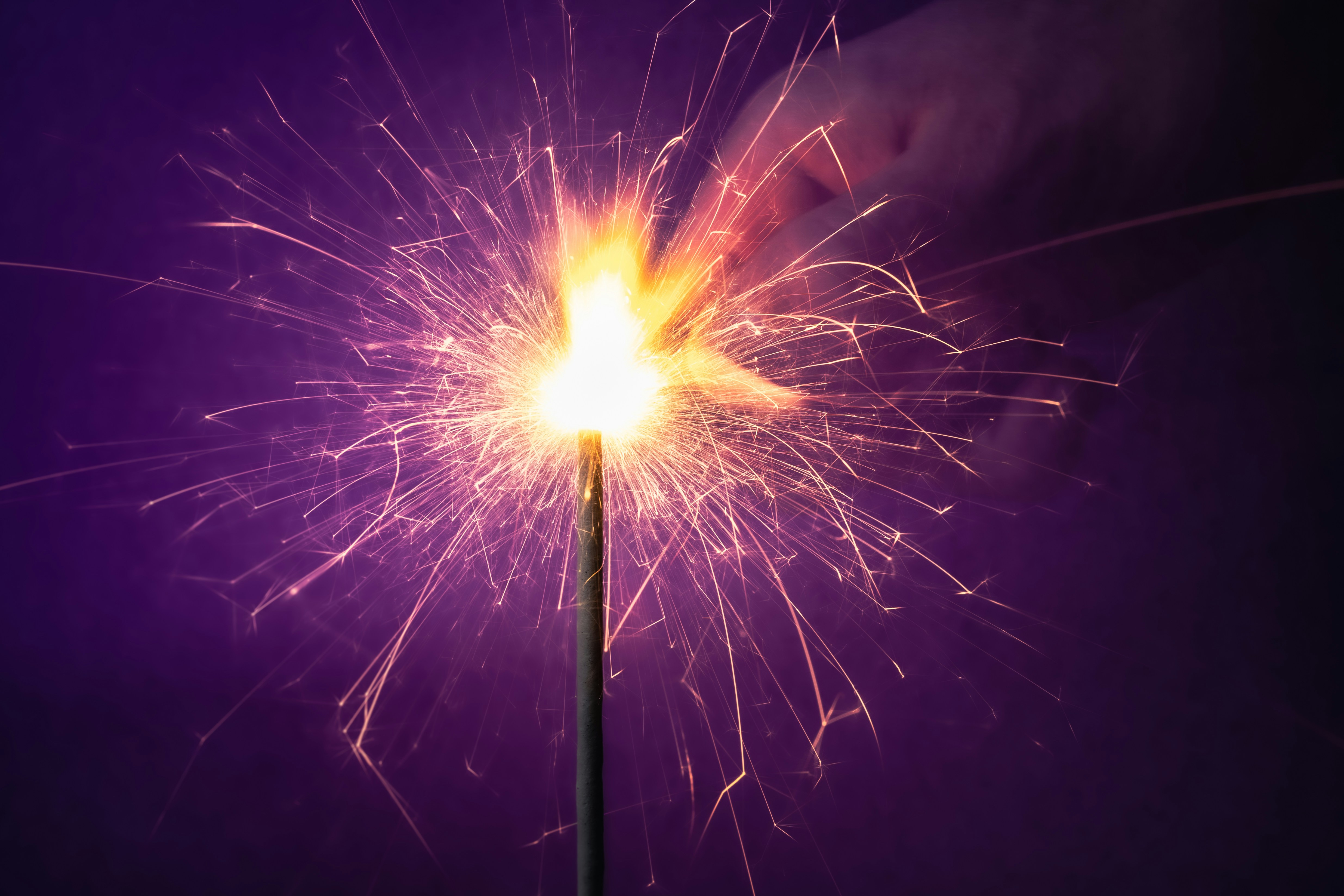 Midnight Violet Spark: Neon Burst from a Handheld Sparkler