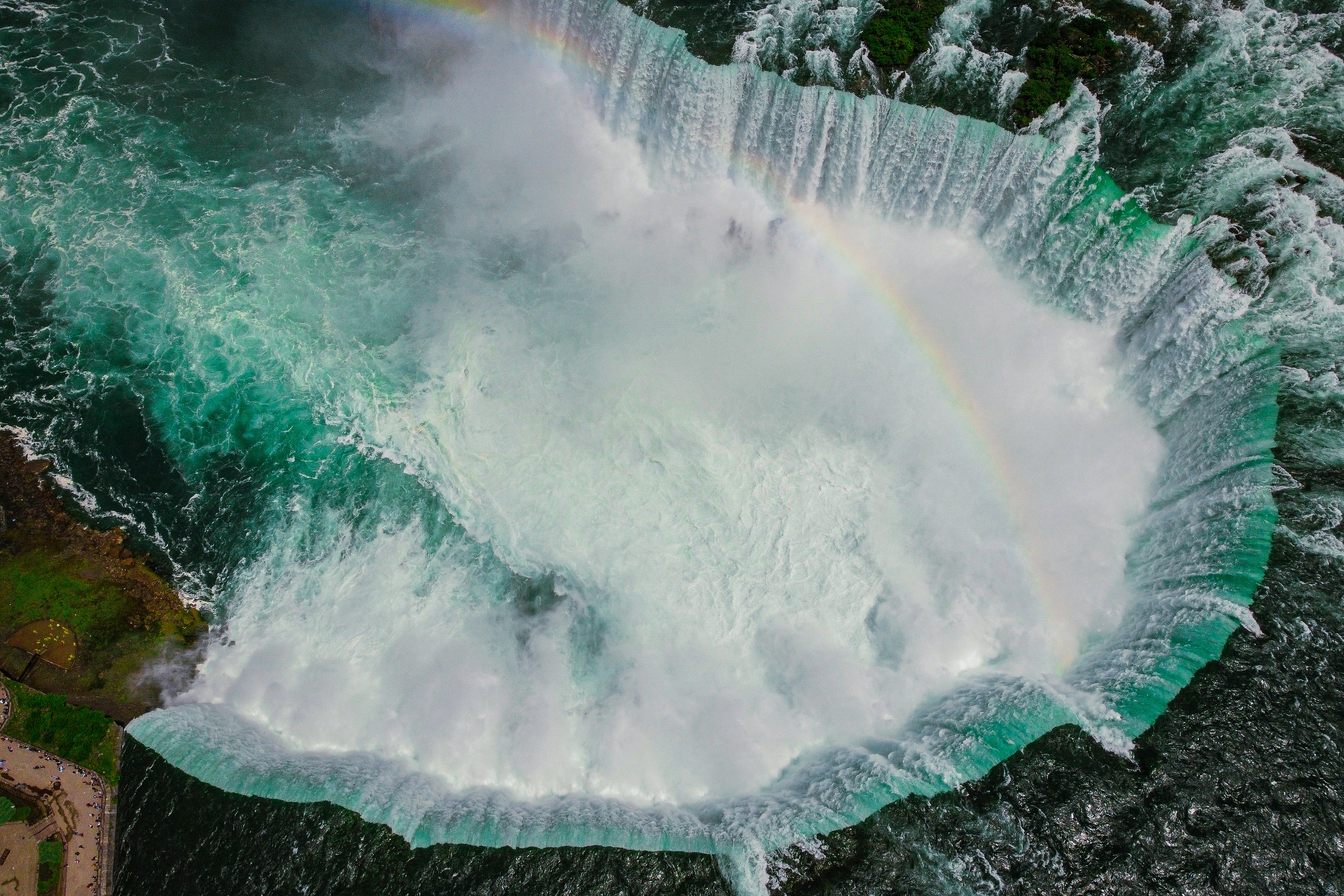 a large waterfall with a rainbow