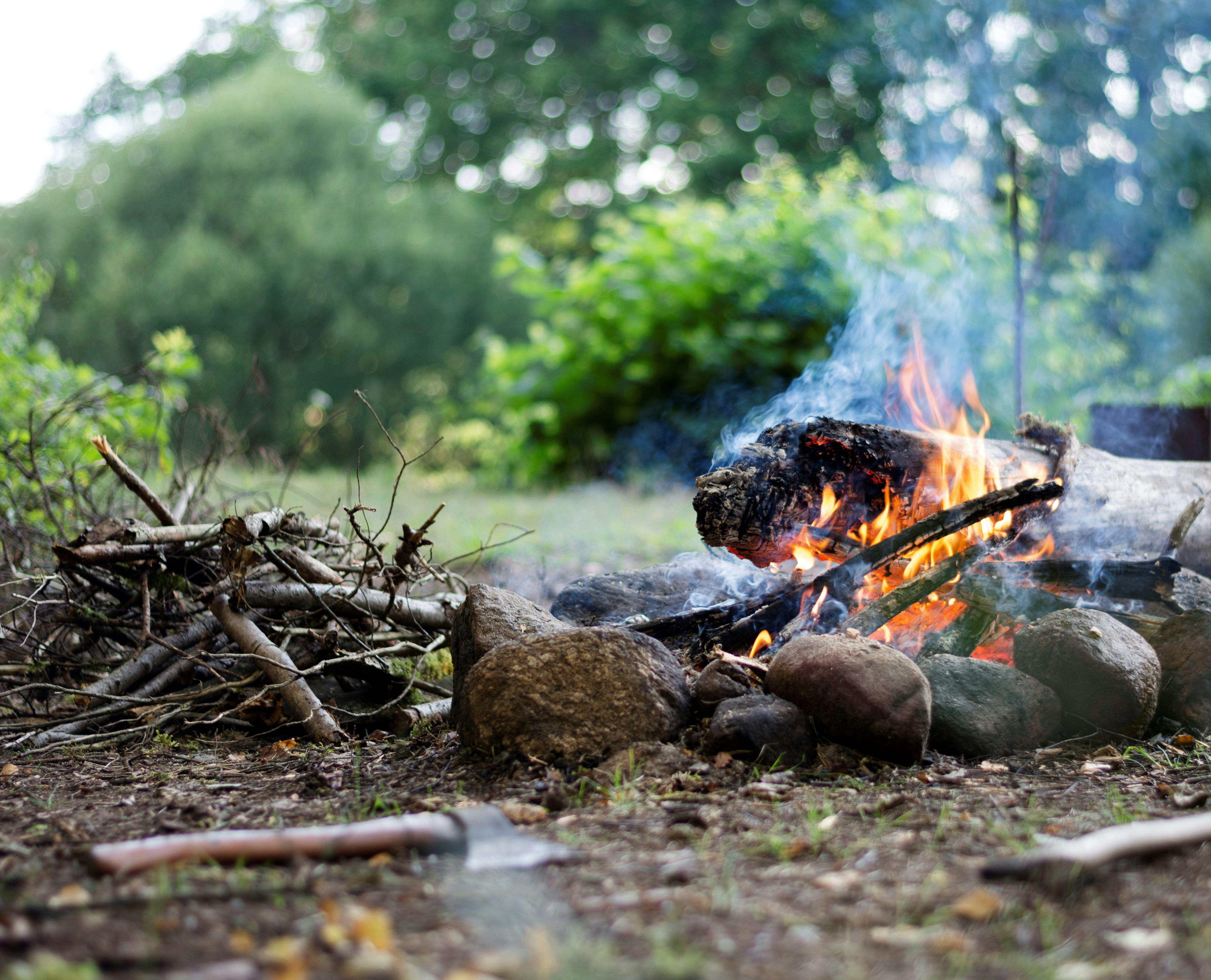 Ember Confluence: Campfire Among Smooth River Stones