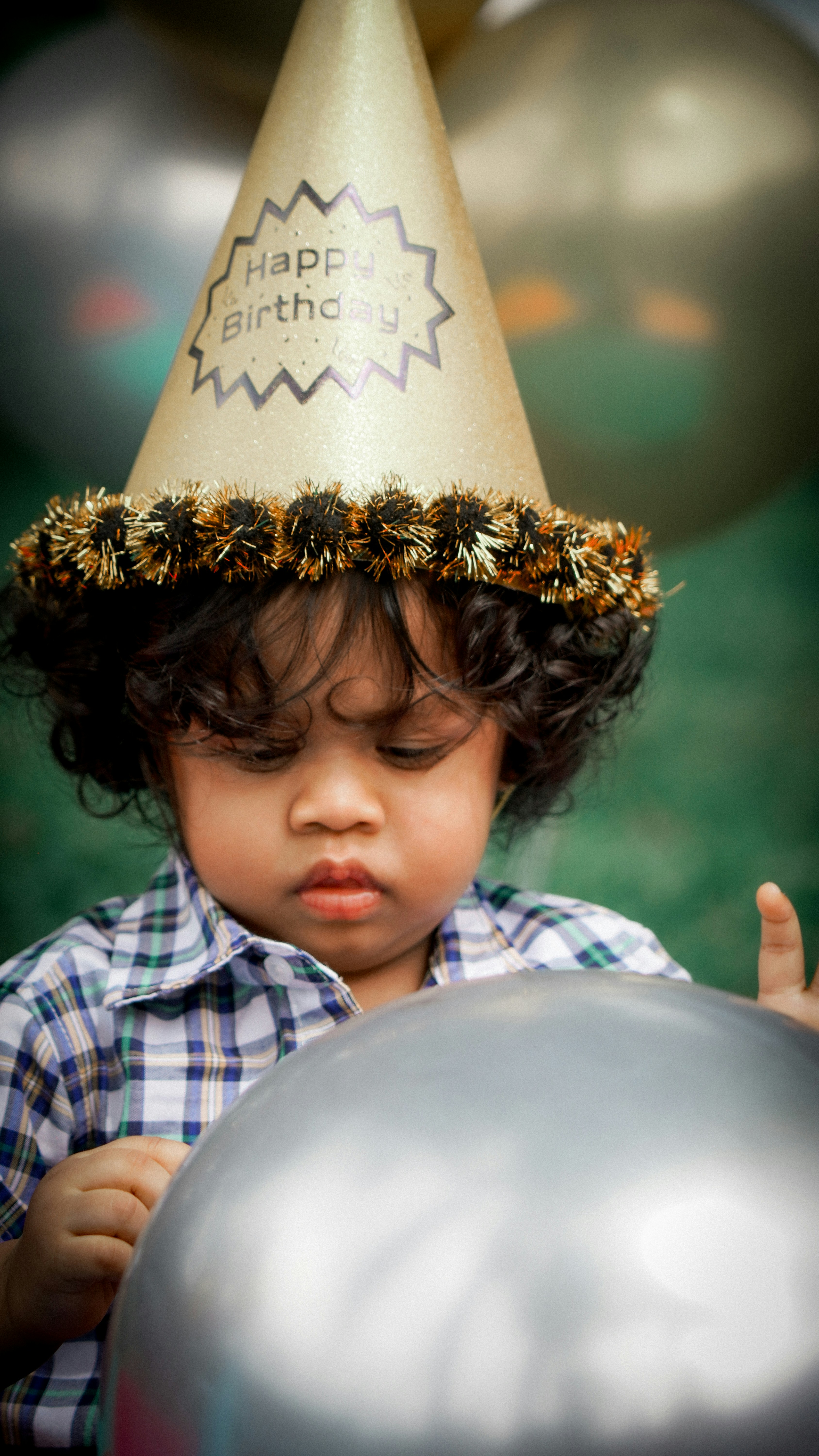 Birthday Crown: A Close-Up of a Child in a Shimmering Party Hat
