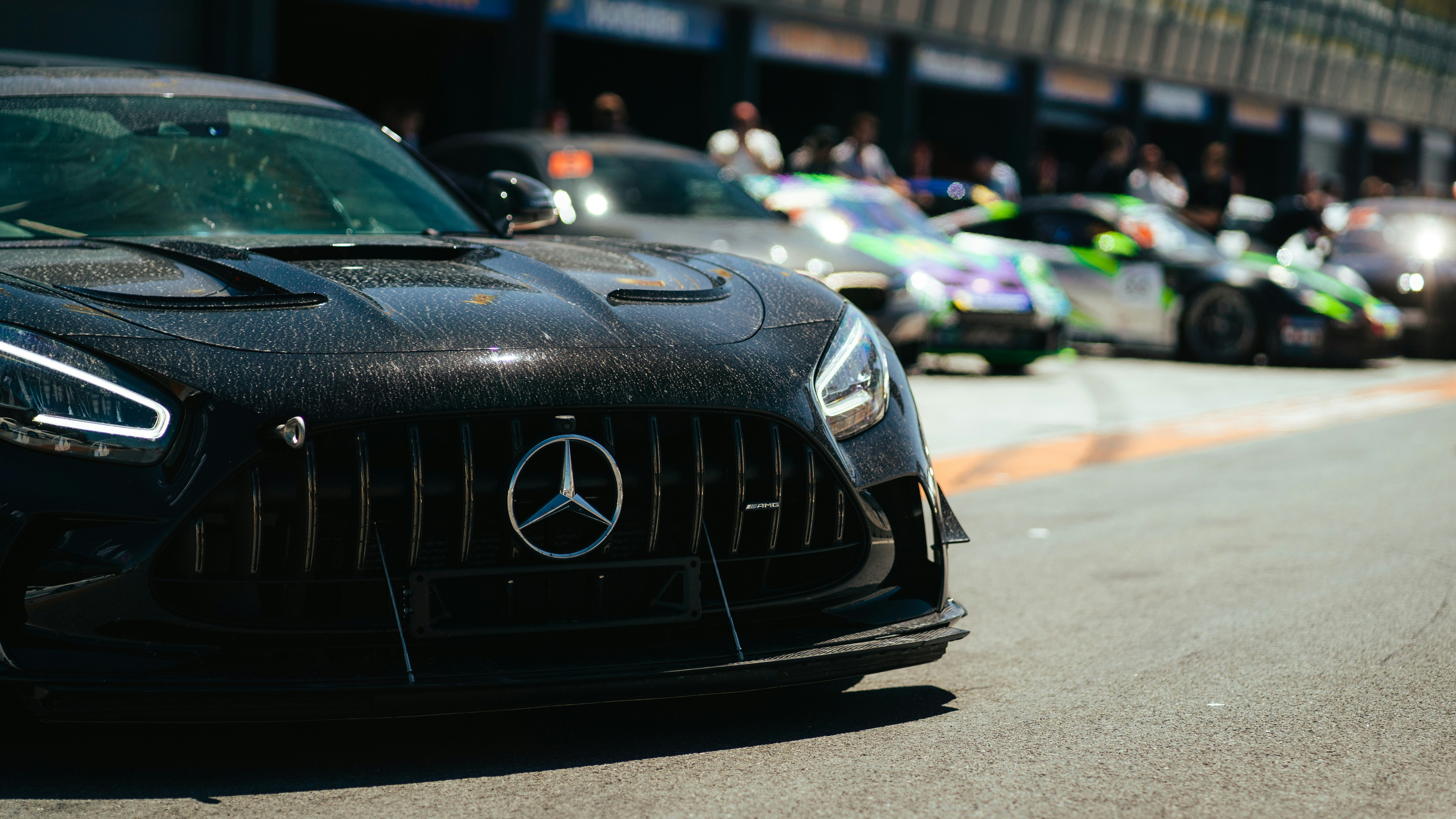 Mercedes-Benz AMG GT Black Series with some Porsches in the background. 