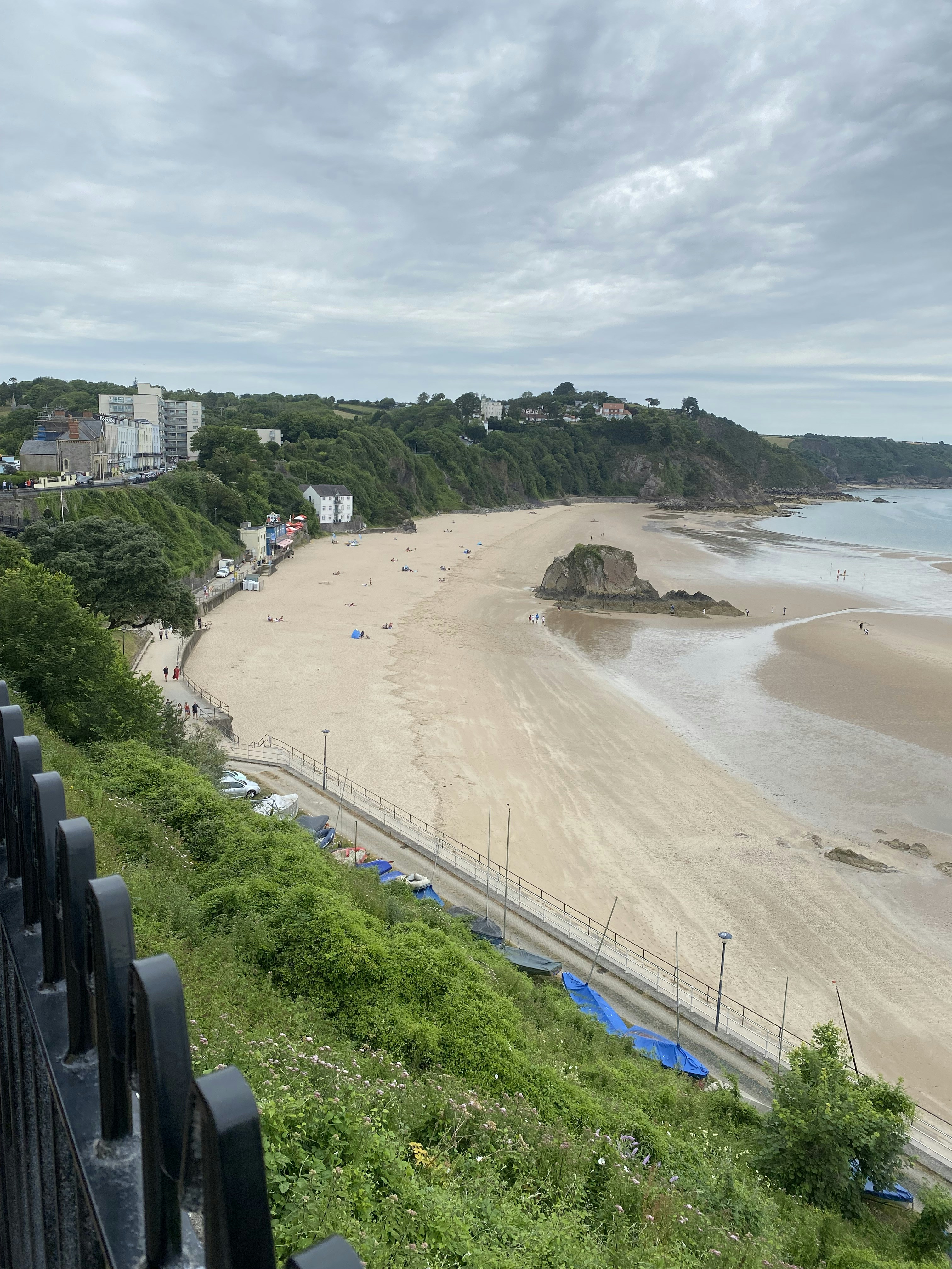 Cliffside Beachfront with Curving Shore and Town Silhouette