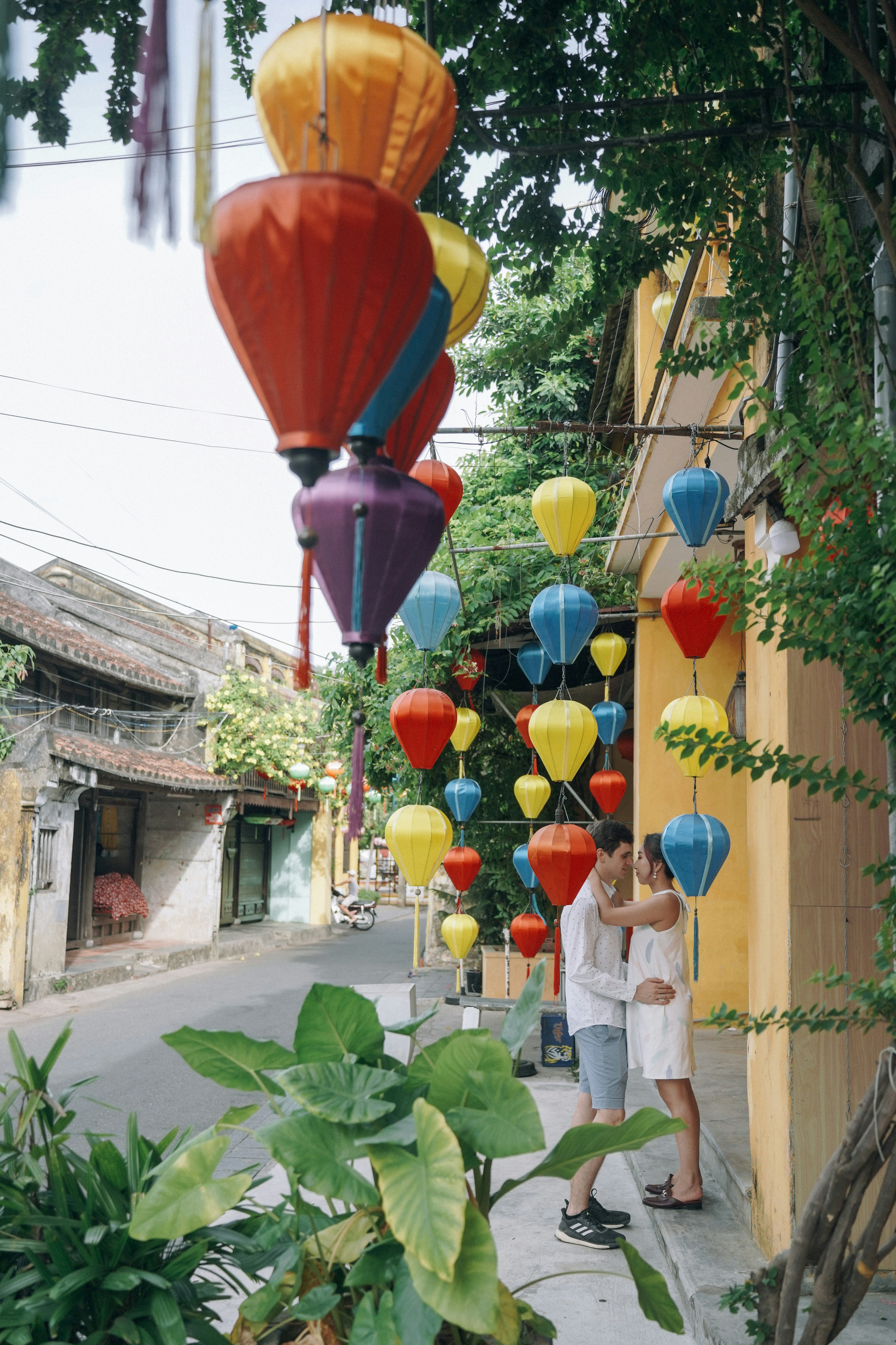 A Lantern-Studded Embrace Beneath a Street of Color