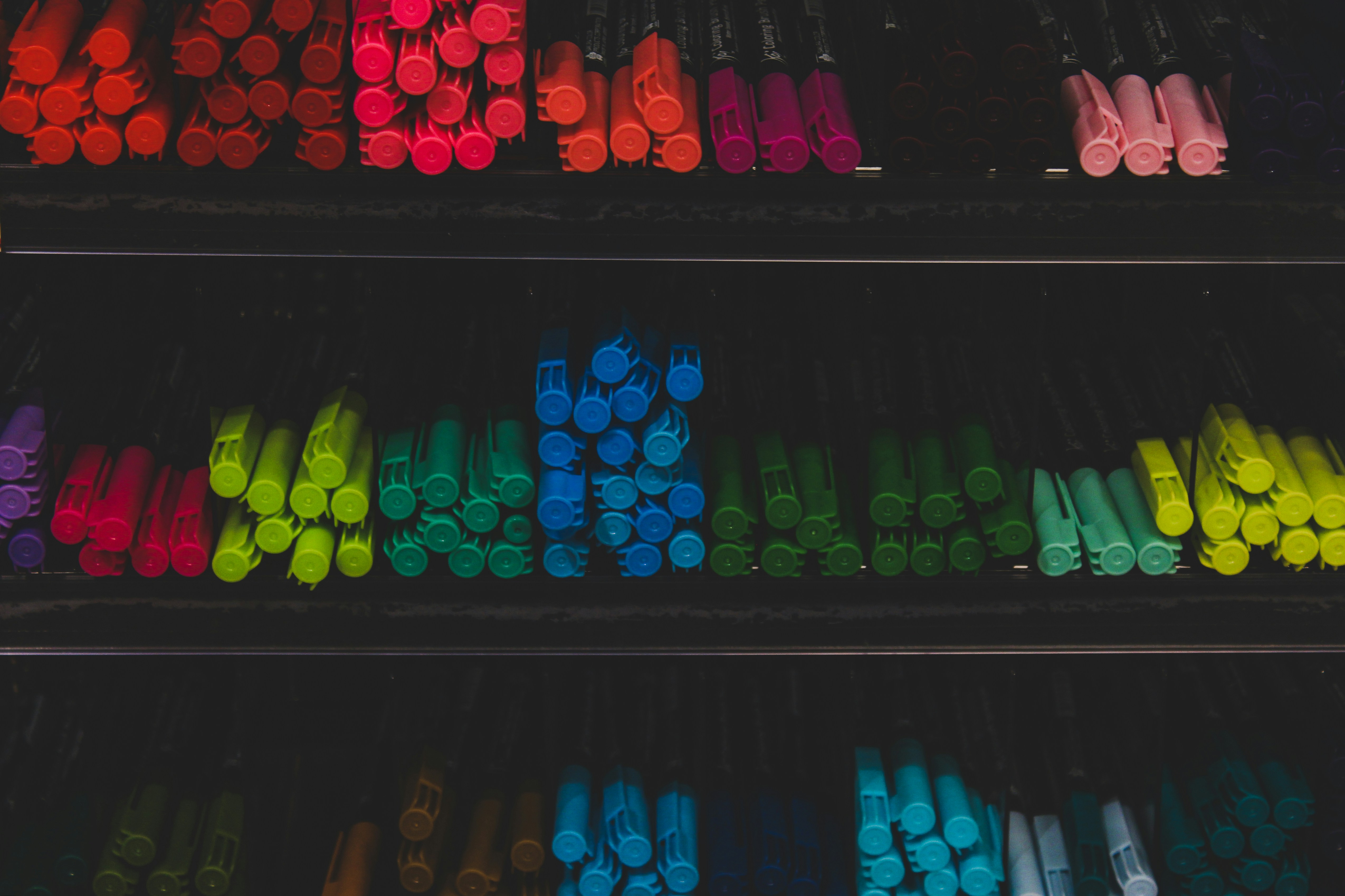 Prismatic Stacks: Neon Marker Caps in a Dark Display