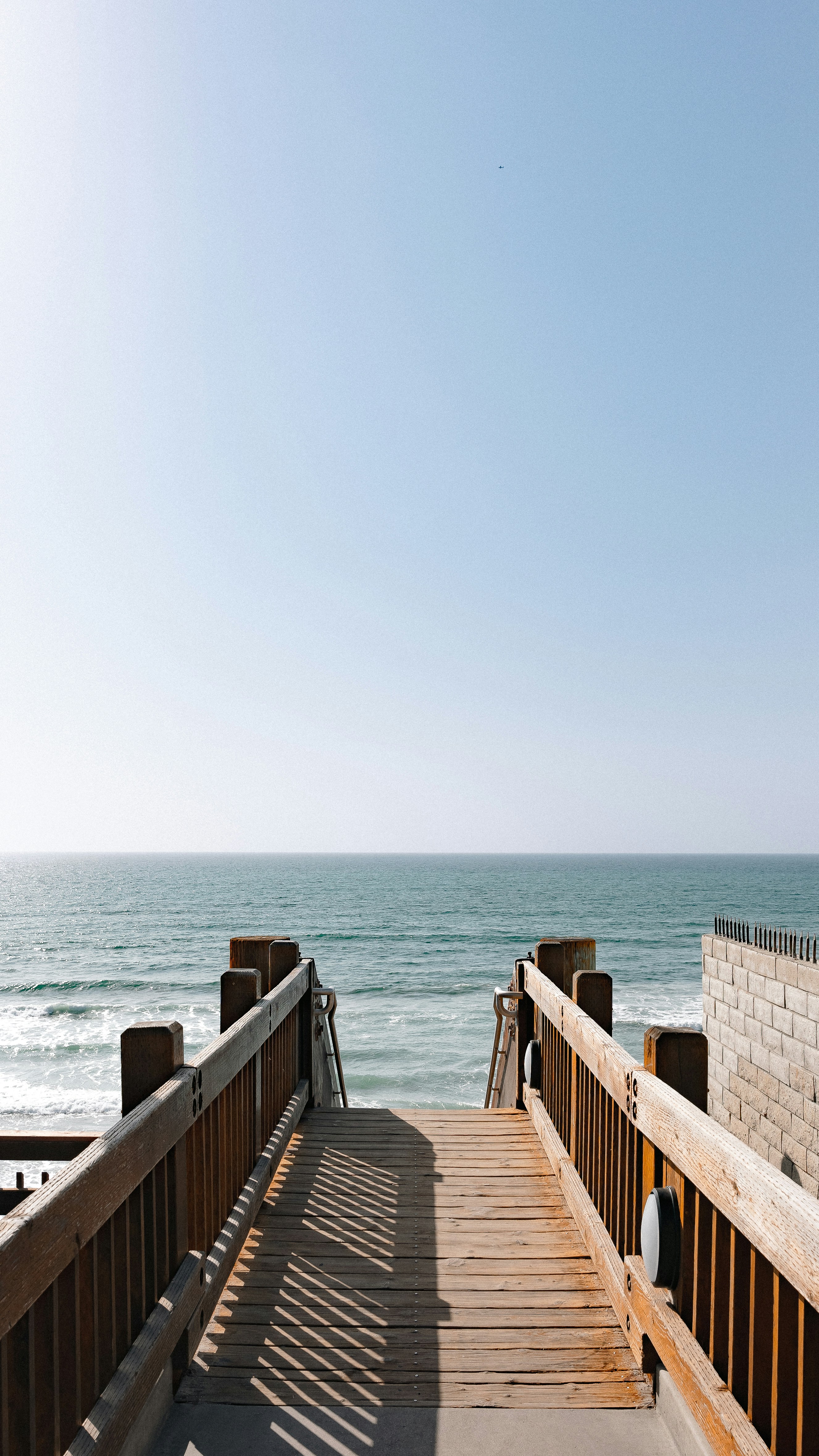 A wooden walkway over water photo – Free Blue Image on Unsplash