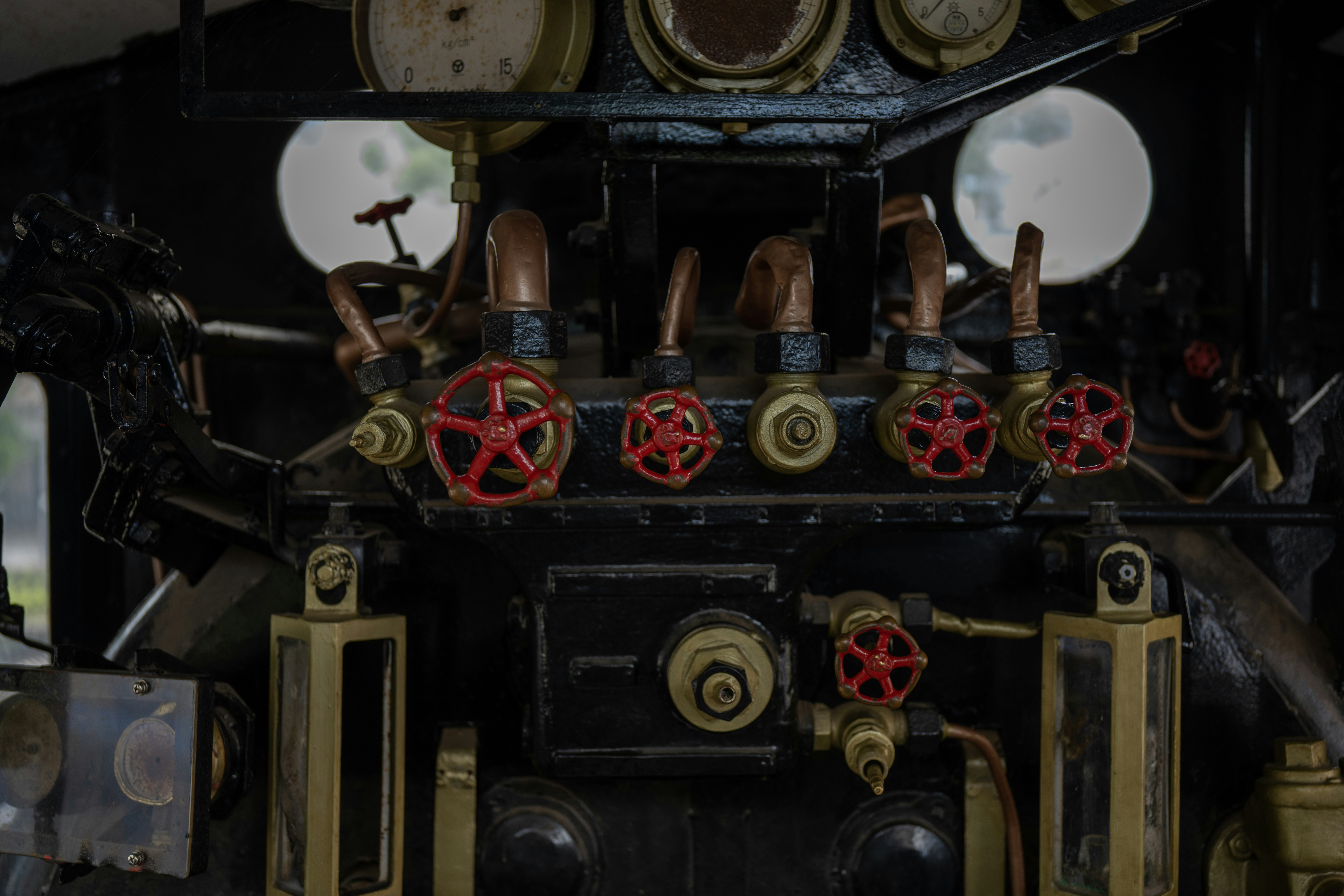 Red Valve Wheels at the Heart of a Vintage Steam Engine Control Panel