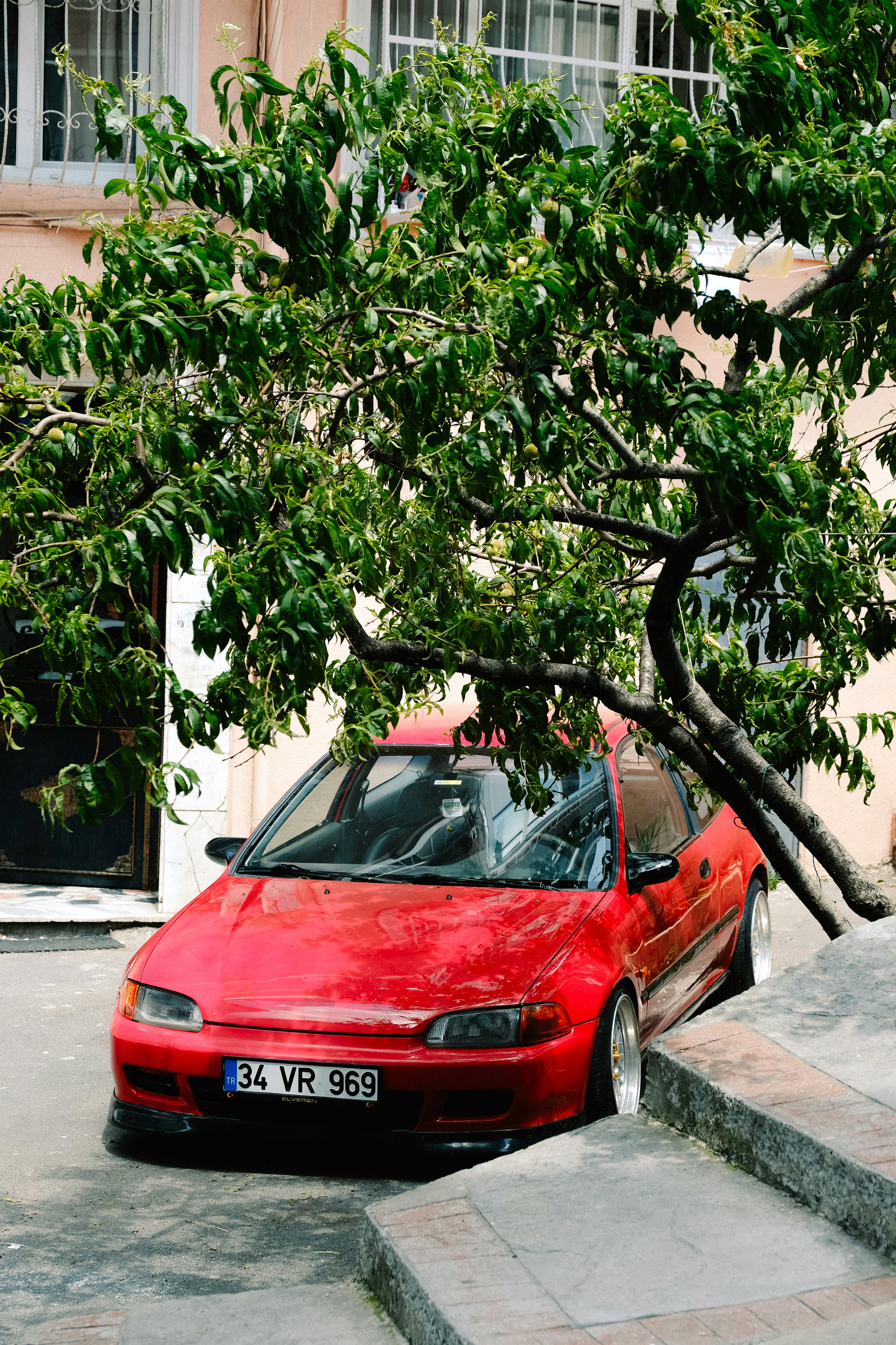 a red car parked on the side of a street