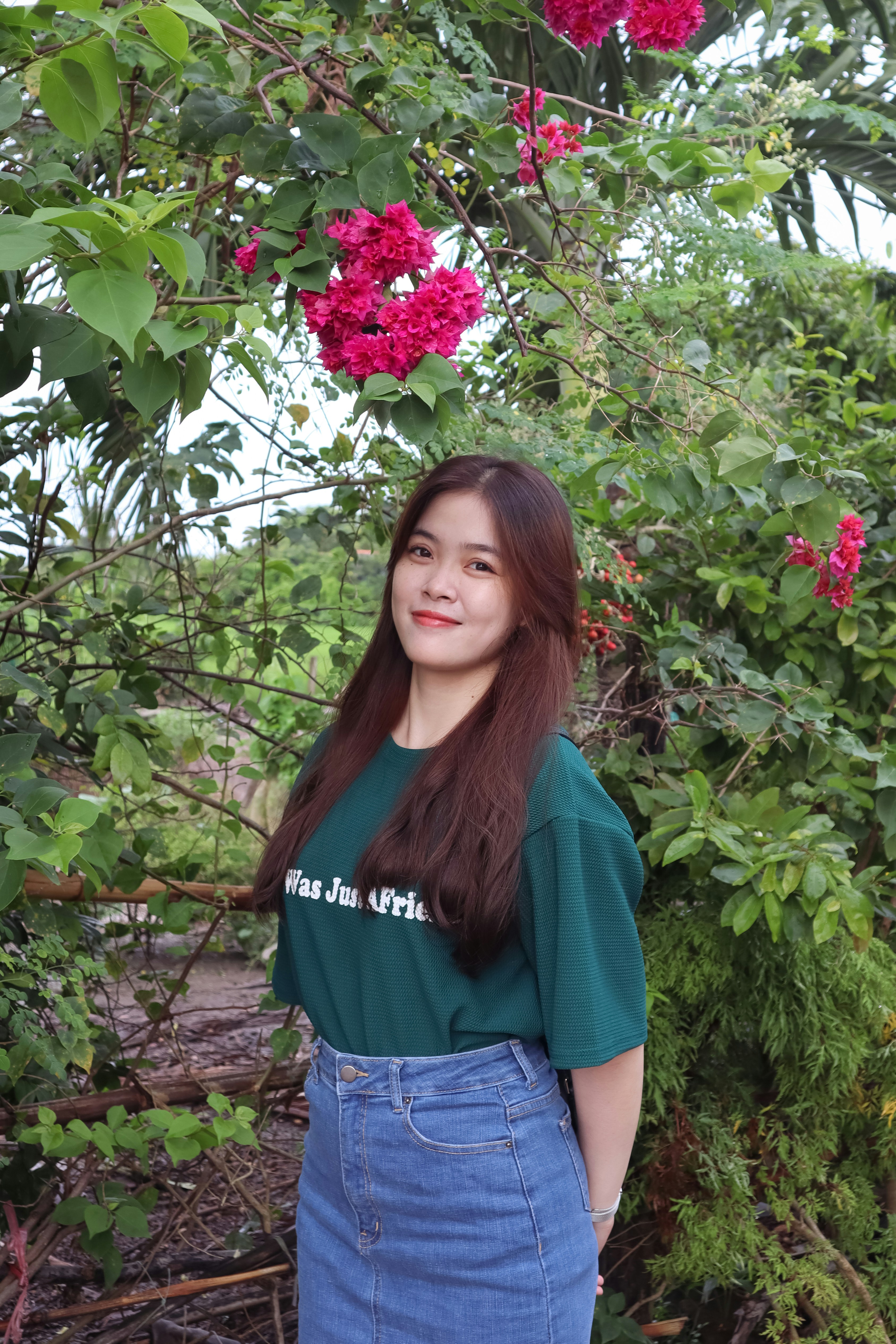 A person standing in front of a bush with flowers photo – Free Outdoors ...
